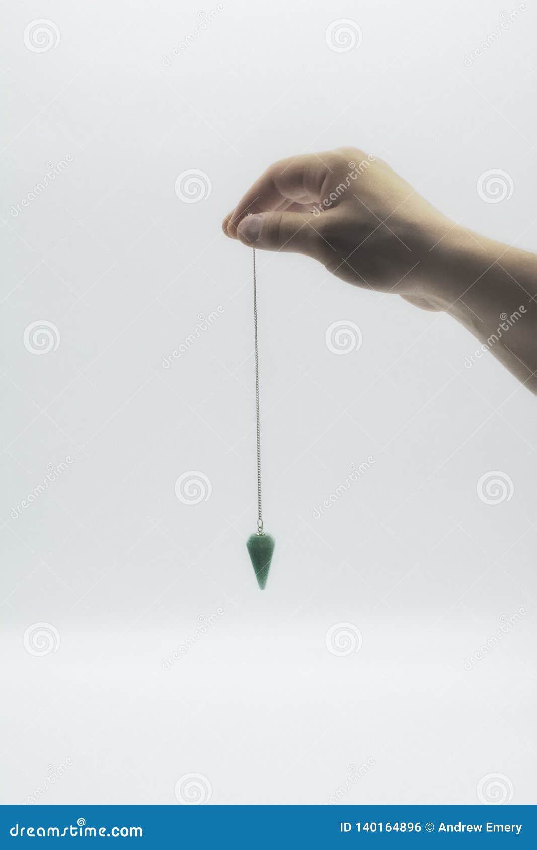 Pendulum Dowsing on an Isolated White Background with a Turquoise ...