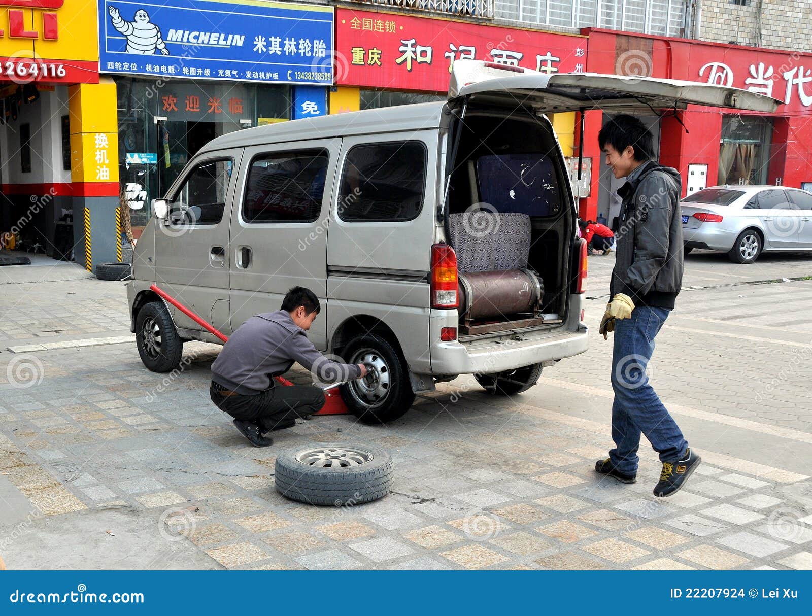 Pengzhou, China: Man Changing Car Tire Editorial Stock Image - Image of ...
