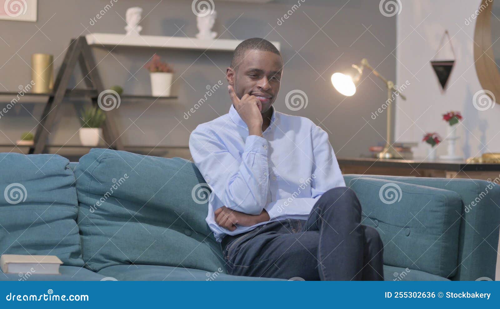 Pensive African Man Thinking while Sitting on Sofa Stock Photo - Image ...