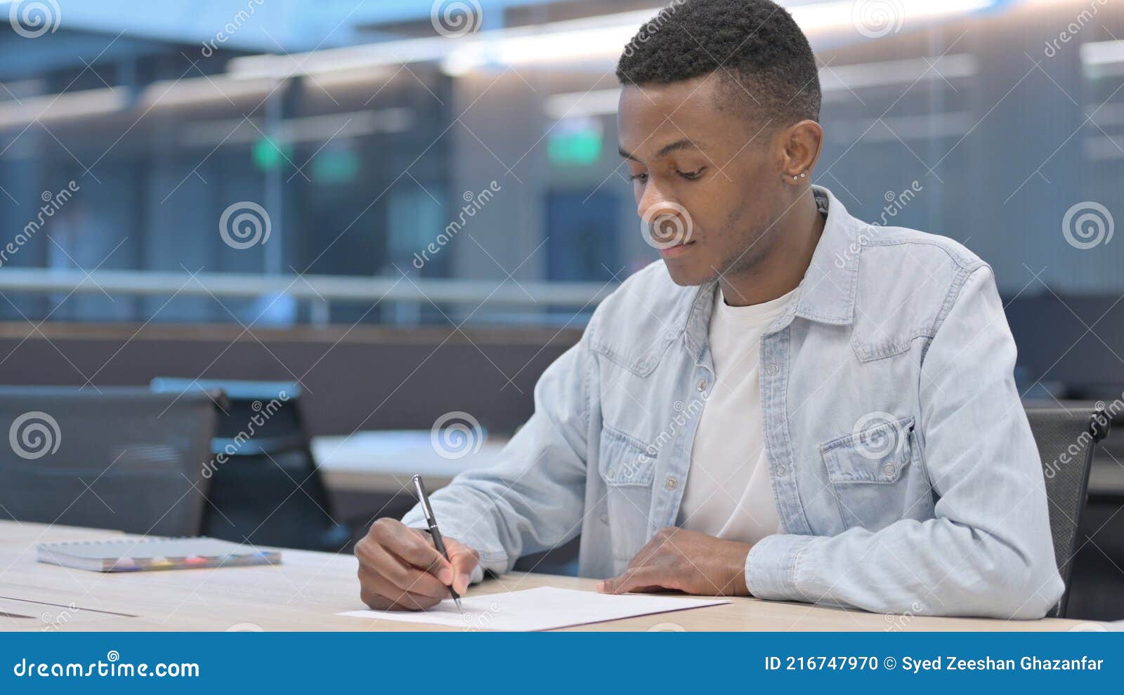Pensive African Man Writing on Paper, Thinking Stock Photo - Image of ...