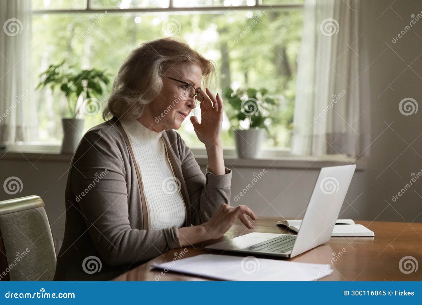 Pensive Aged Female Pensioner Work by Laptop Computer from Home Stock ...