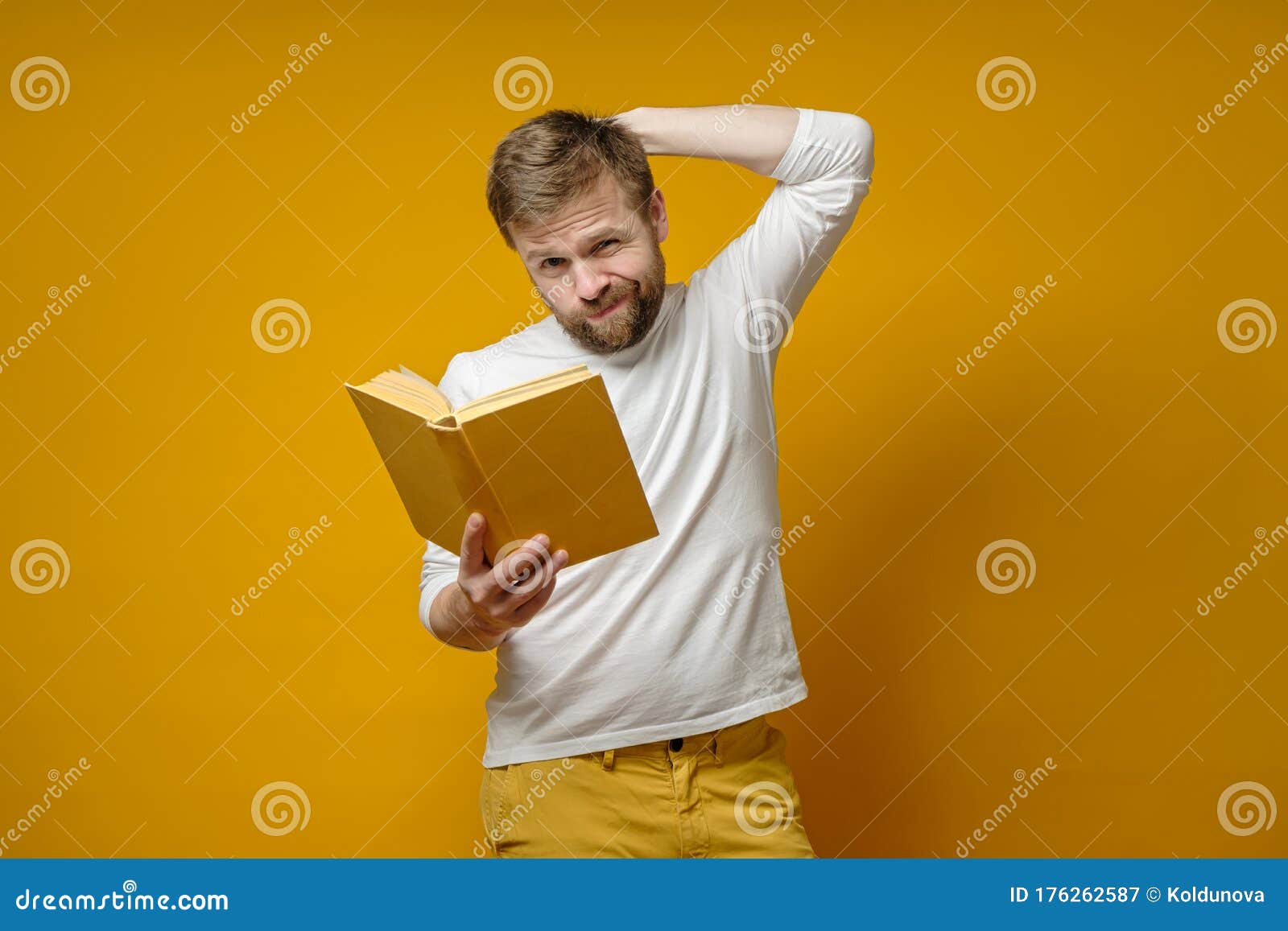 Pensive Bearded Man Holds In Hands A Book That He Has Read To The