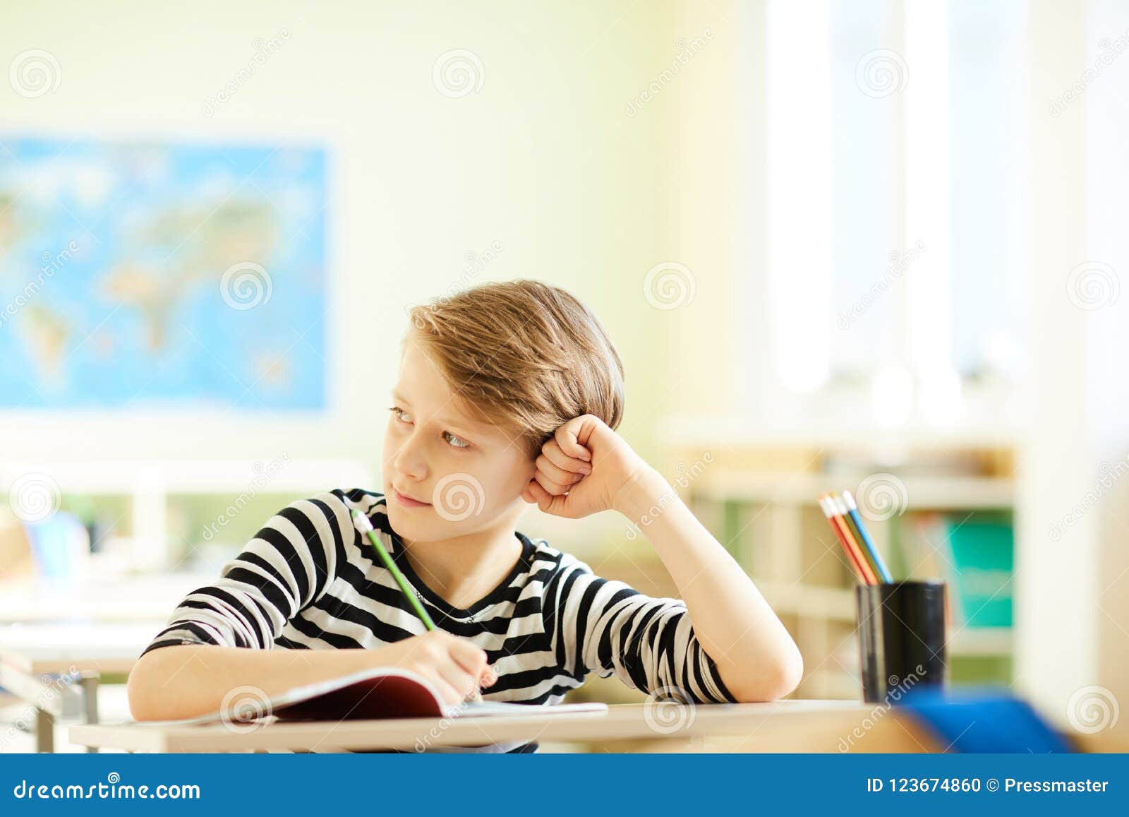 Pensive Boy Doing Task in Classroom Stock Photo - Image of leaning ...