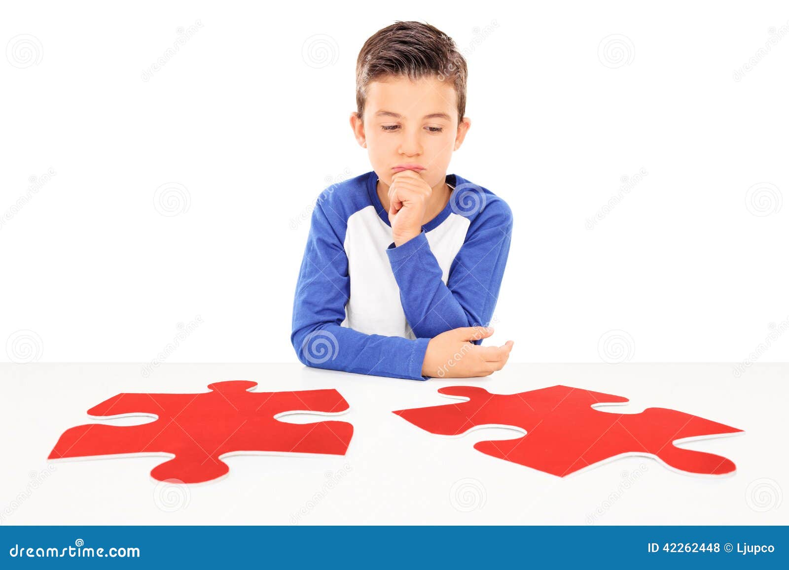 Pensive Boy Looking at Two Pieces of Puzzle Stock Photo - Image of ...