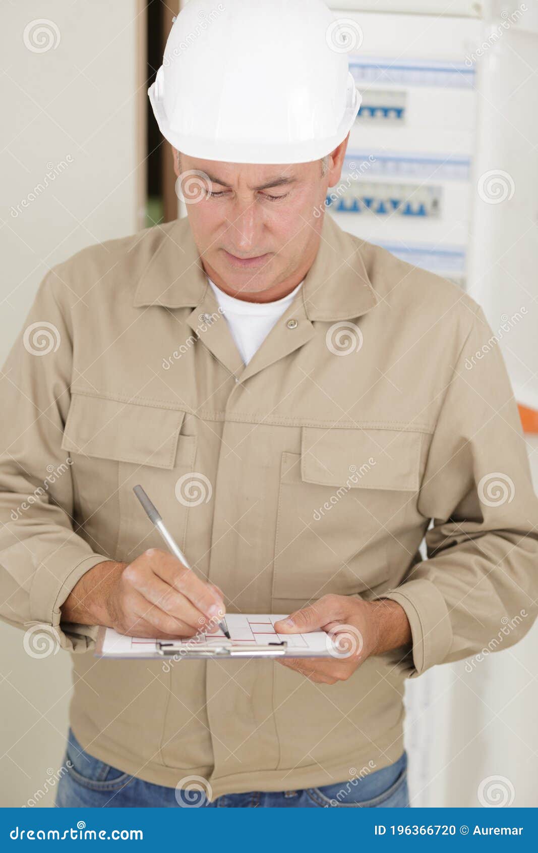 Pensive Builder Writing on Clipboard Stock Photo - Image of profession ...