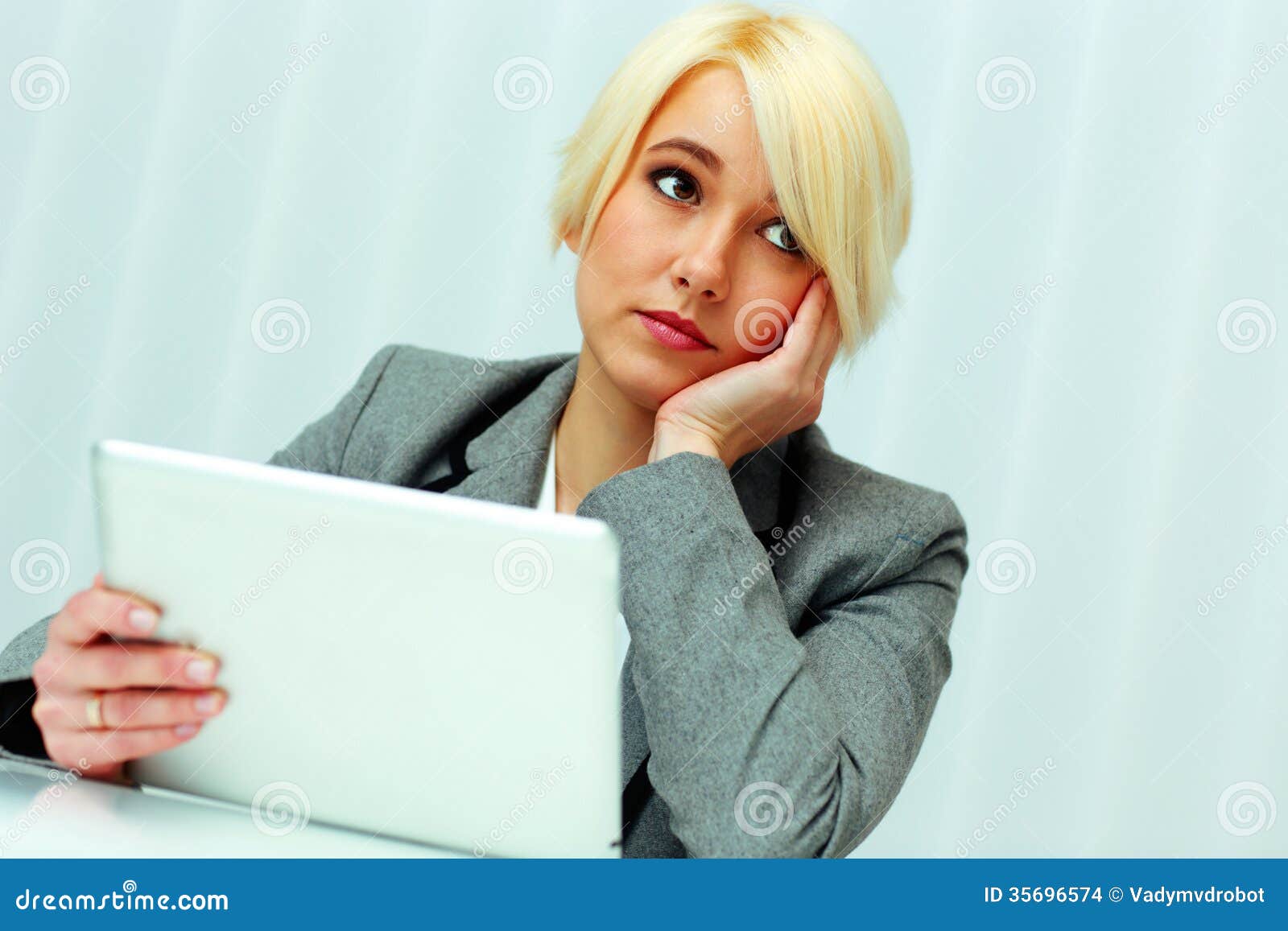 Pensive Businesswoman with Tablet Computer Looking Away Stock Photo ...