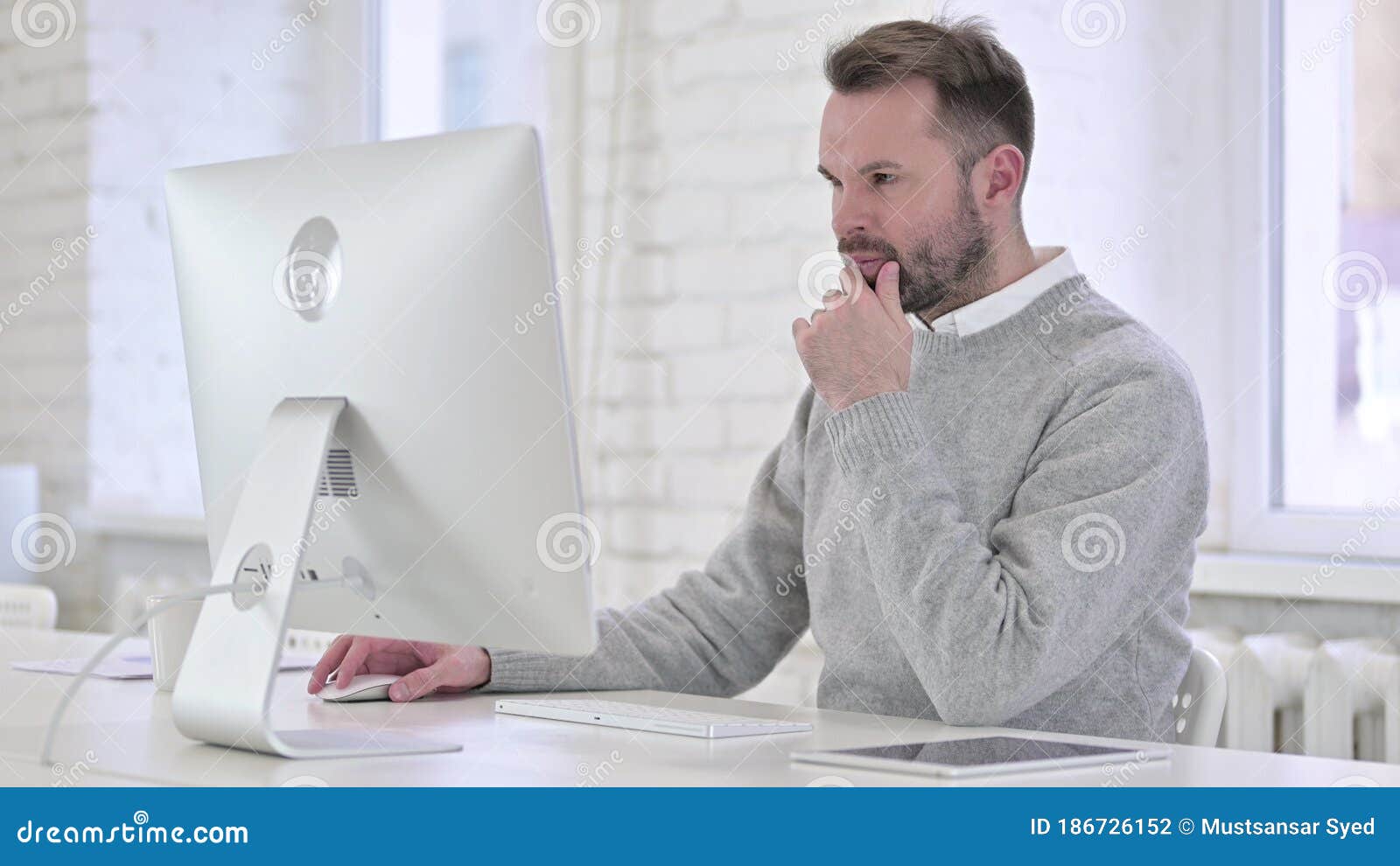 Pensive Creative Man Thinking and Working on Desktop Stock Photo ...