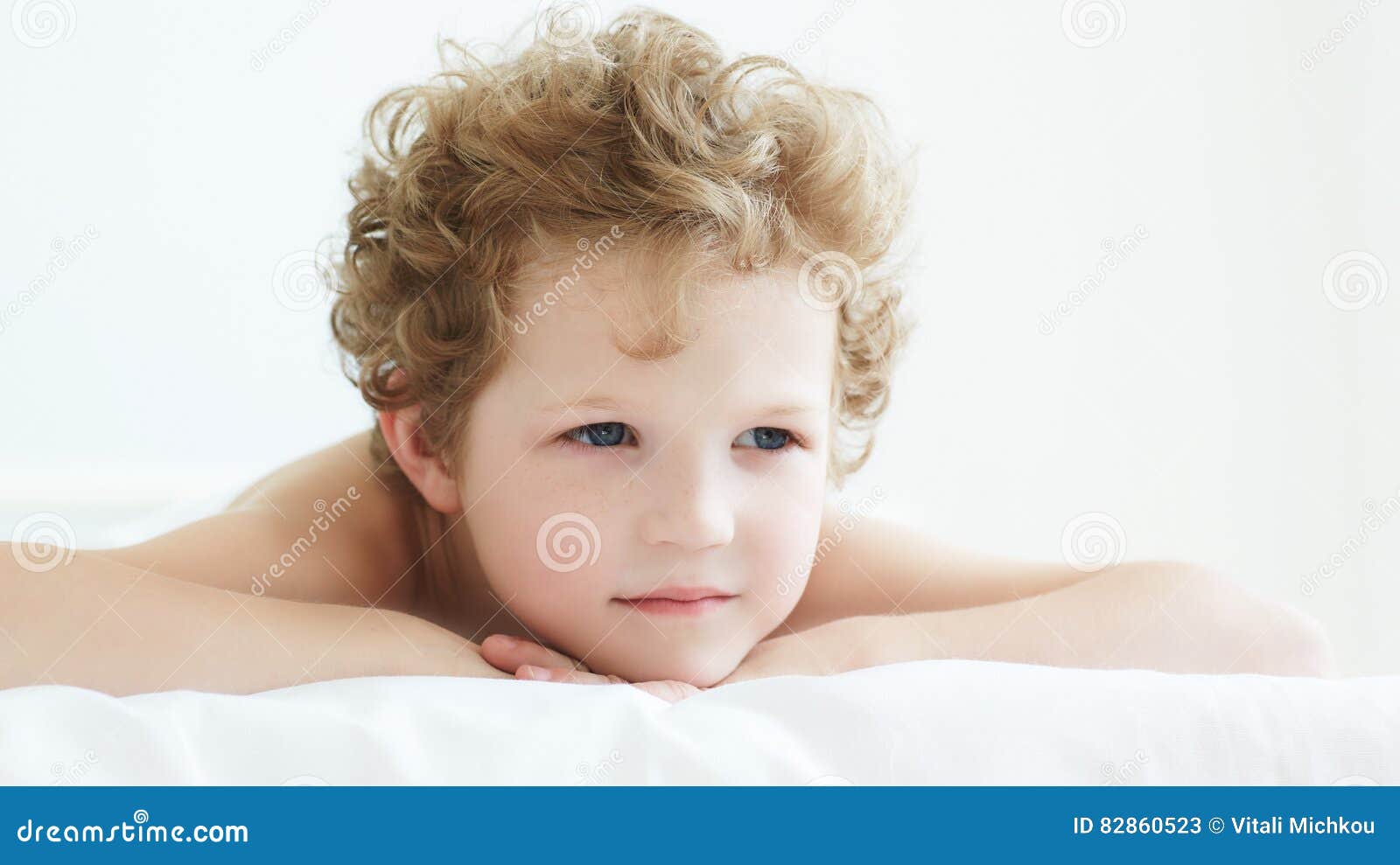 Pensive Curly-haired Boy Lying in Bed. Stock Image - Image of beautiful ...