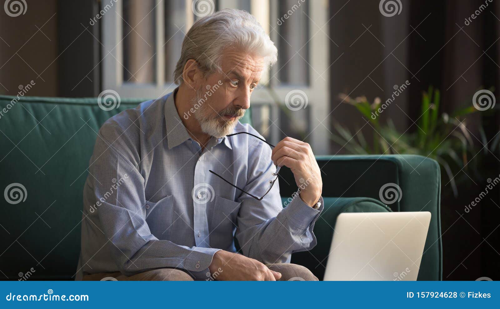 Pensive Mature Man Distracted from Computer Thinking Stock Photo ...