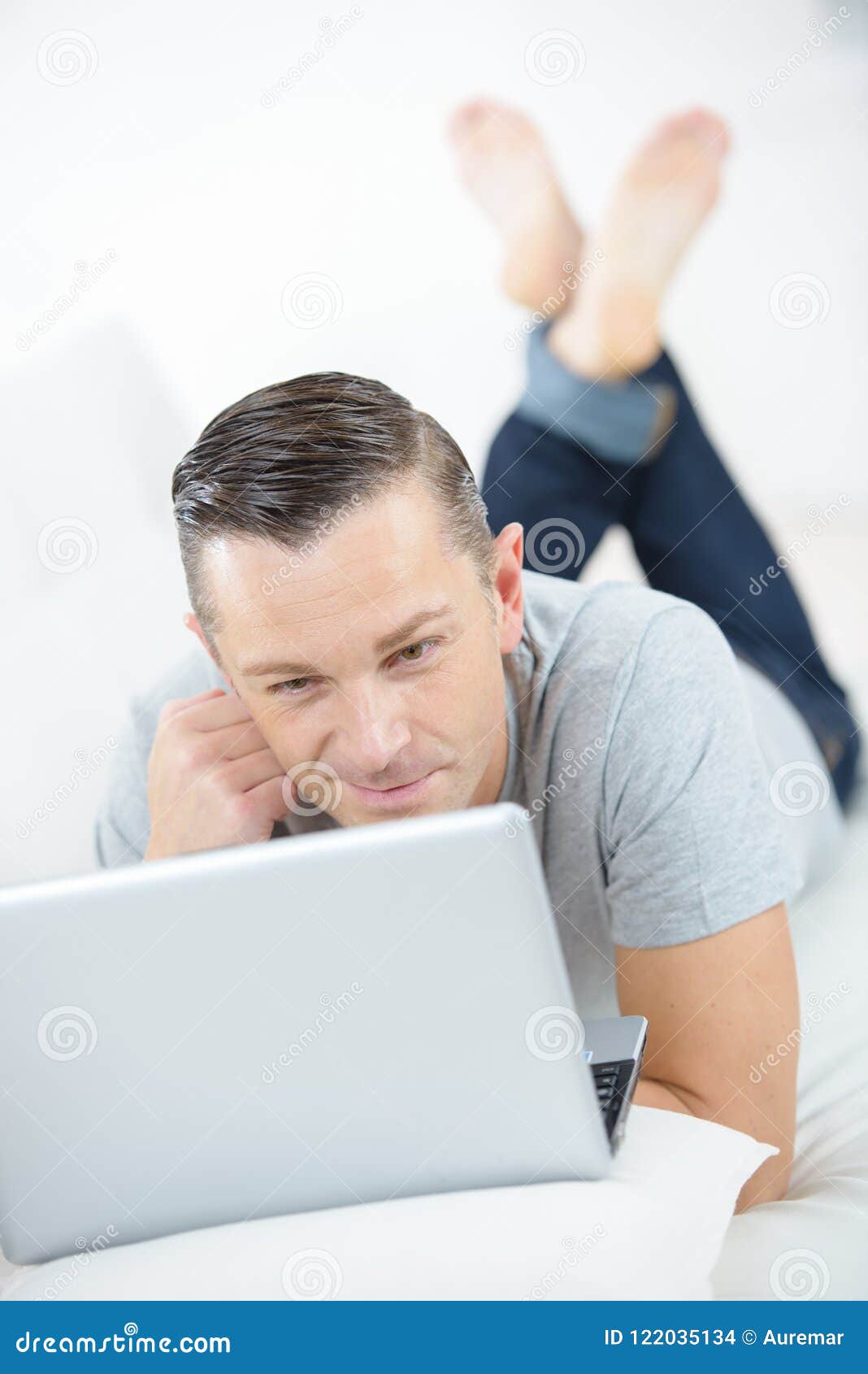 Pensive Guy Lying on Bed with Laptop Stock Photo - Image of morning ...