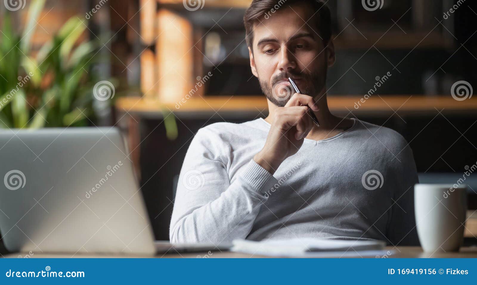 Pensive Male Thinking Over Problem Solution Working on Laptop Stock ...
