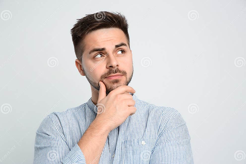 Pensive Man on Light Background. Thinking about Answer for Question ...