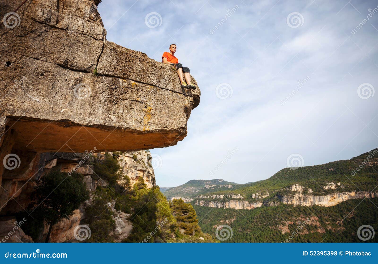 Pensive Man Sitting on Edge of Cliff Stock Photo - Image of freedom ...