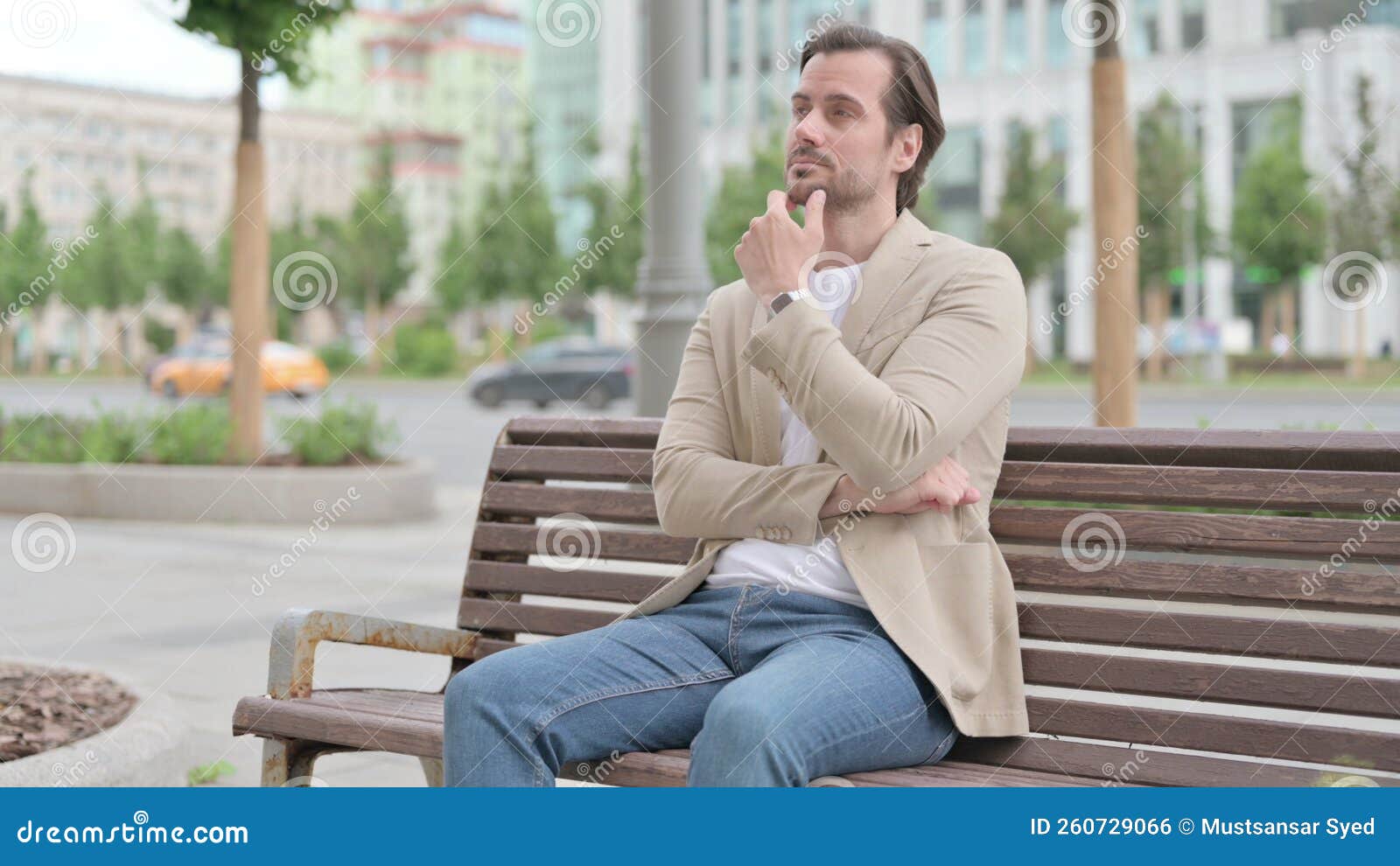 Pensive Young Man Thinking while Sitting on Bench Stock Photo - Image ...