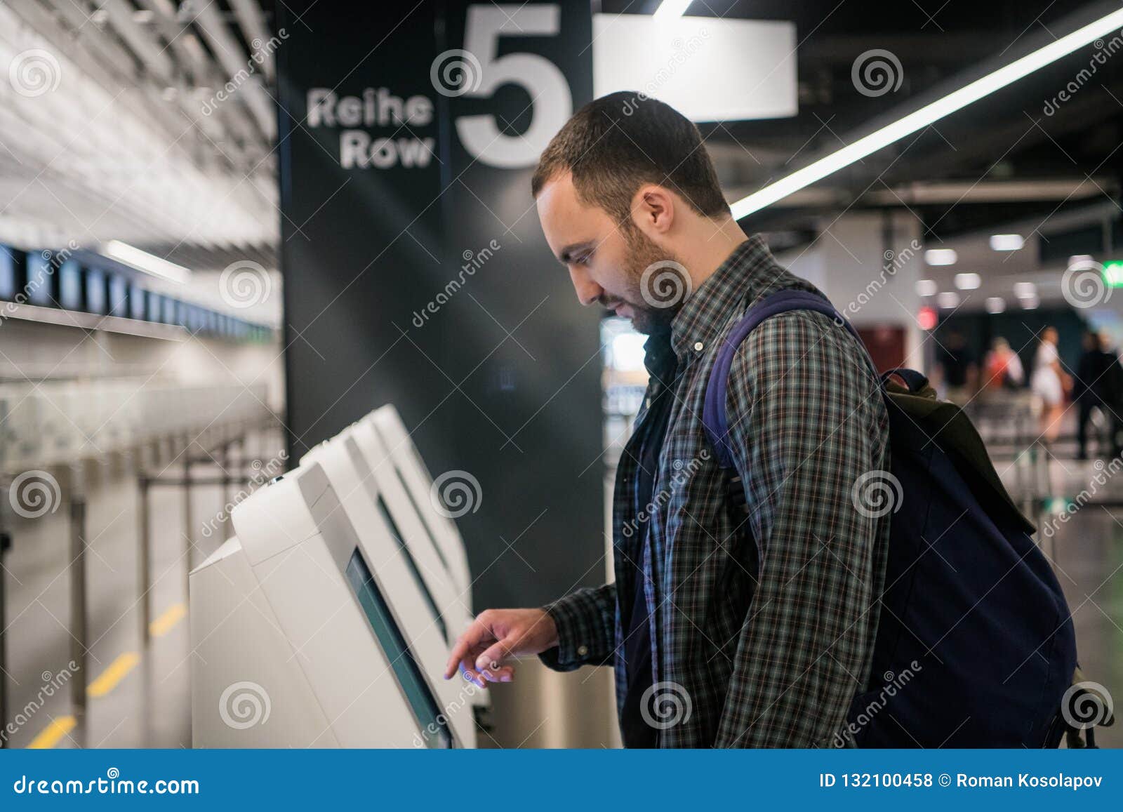 Pensive Man Using the Check-in Machine at the Airport Getting the ...