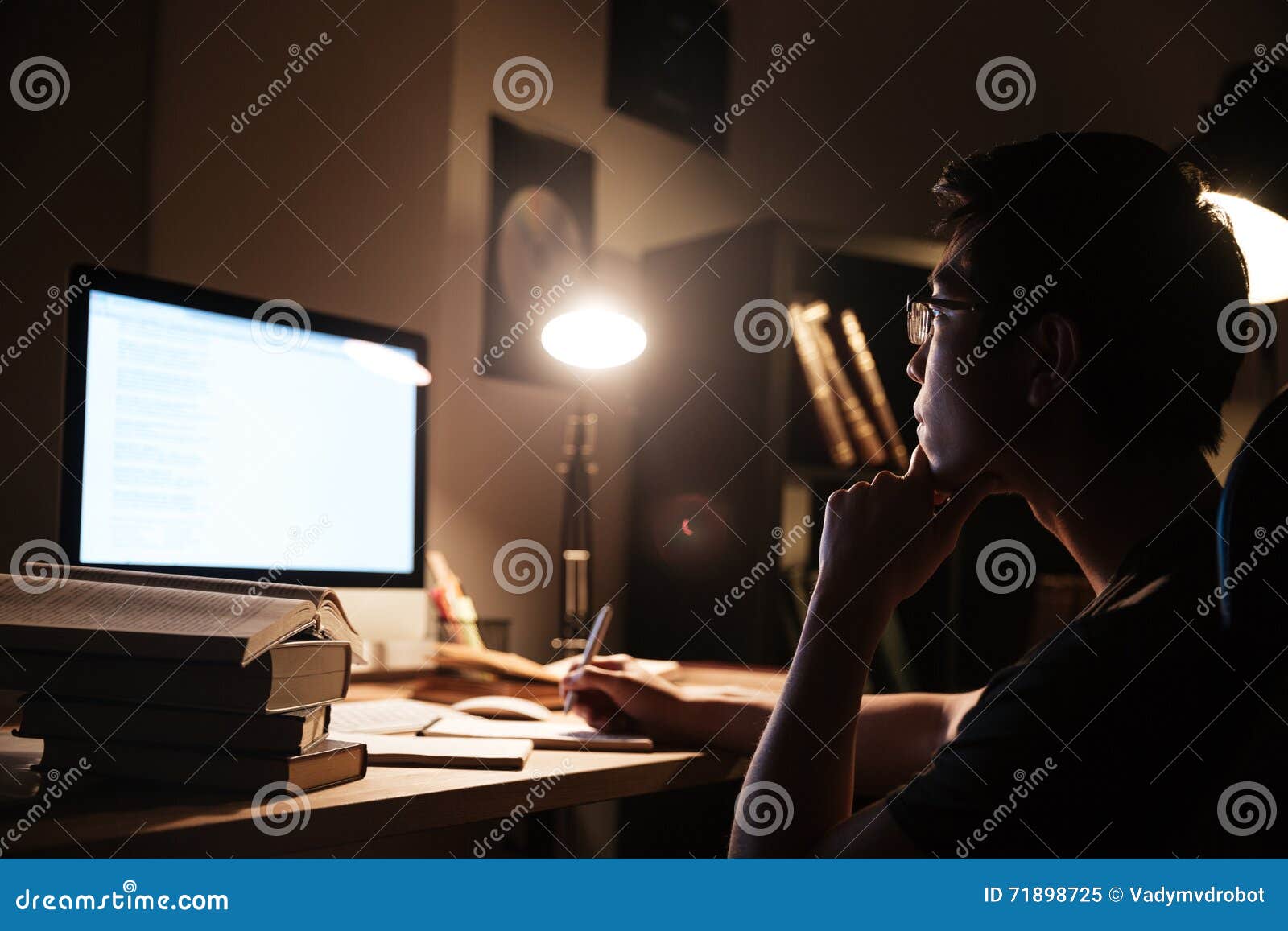 Pensive Man Writing and Working with Computer in Dark Room Stock Image ...