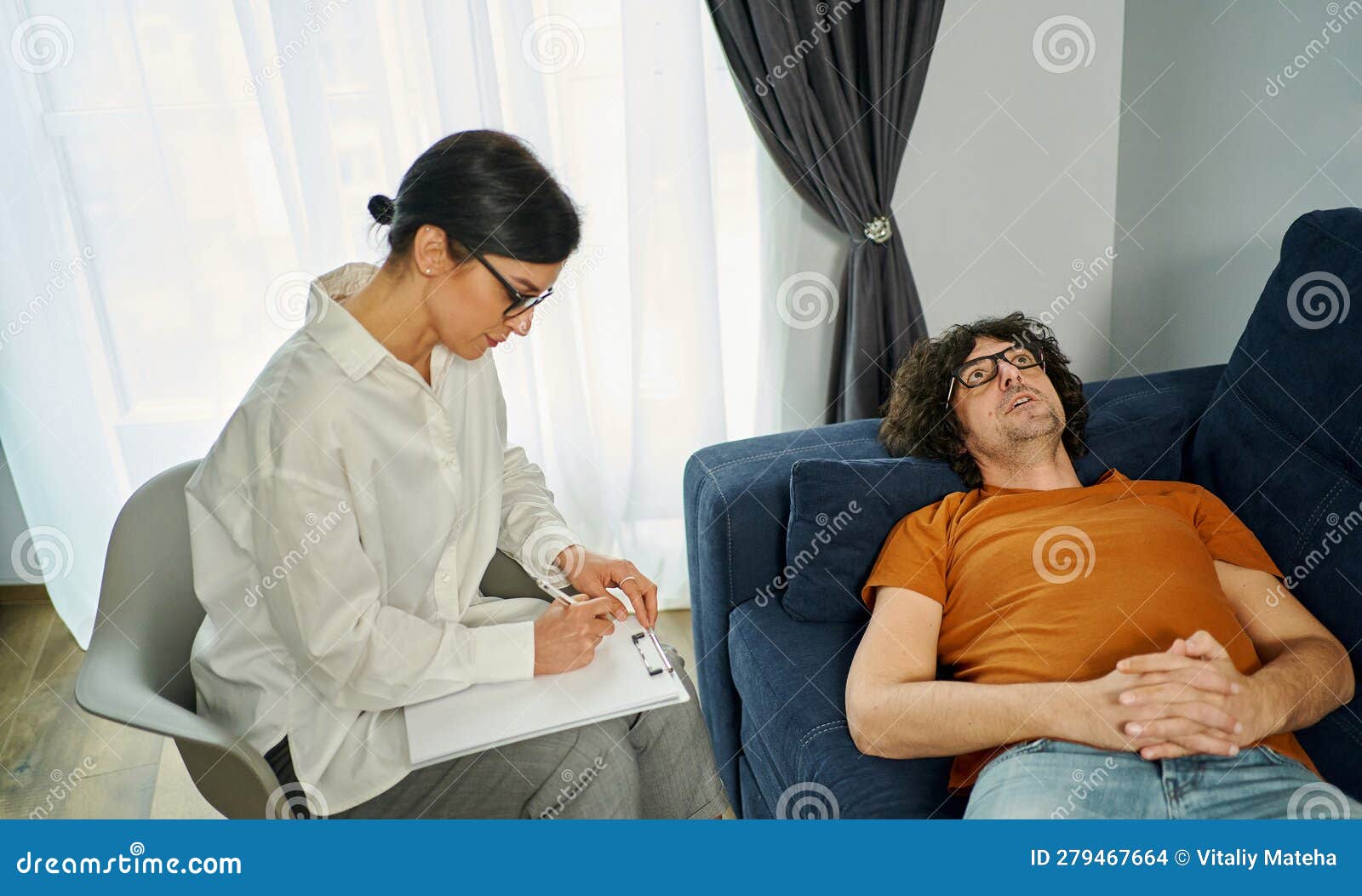 Pensive Man Telling about Problems while Female Therapist Taking Notes ...