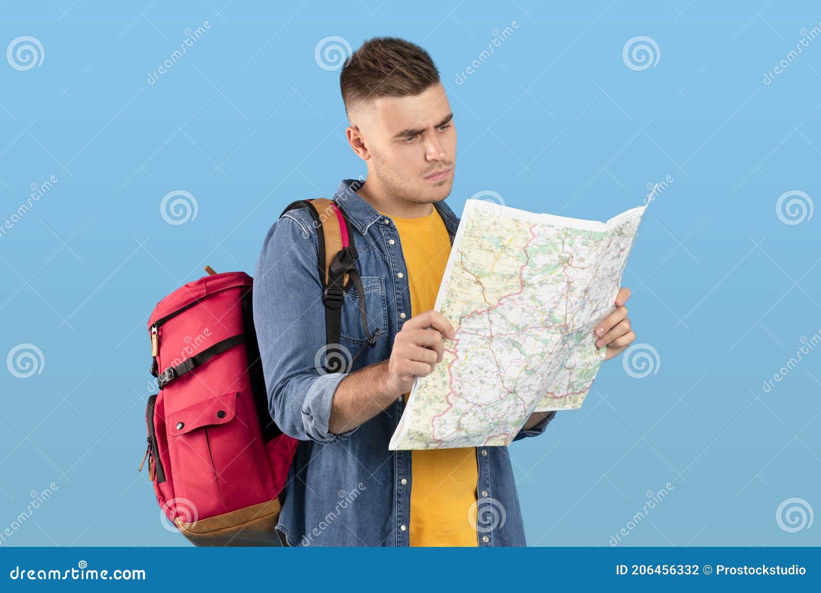 Pensive Young Backpacker Looking at Map with Concern, Feeling Lost ...