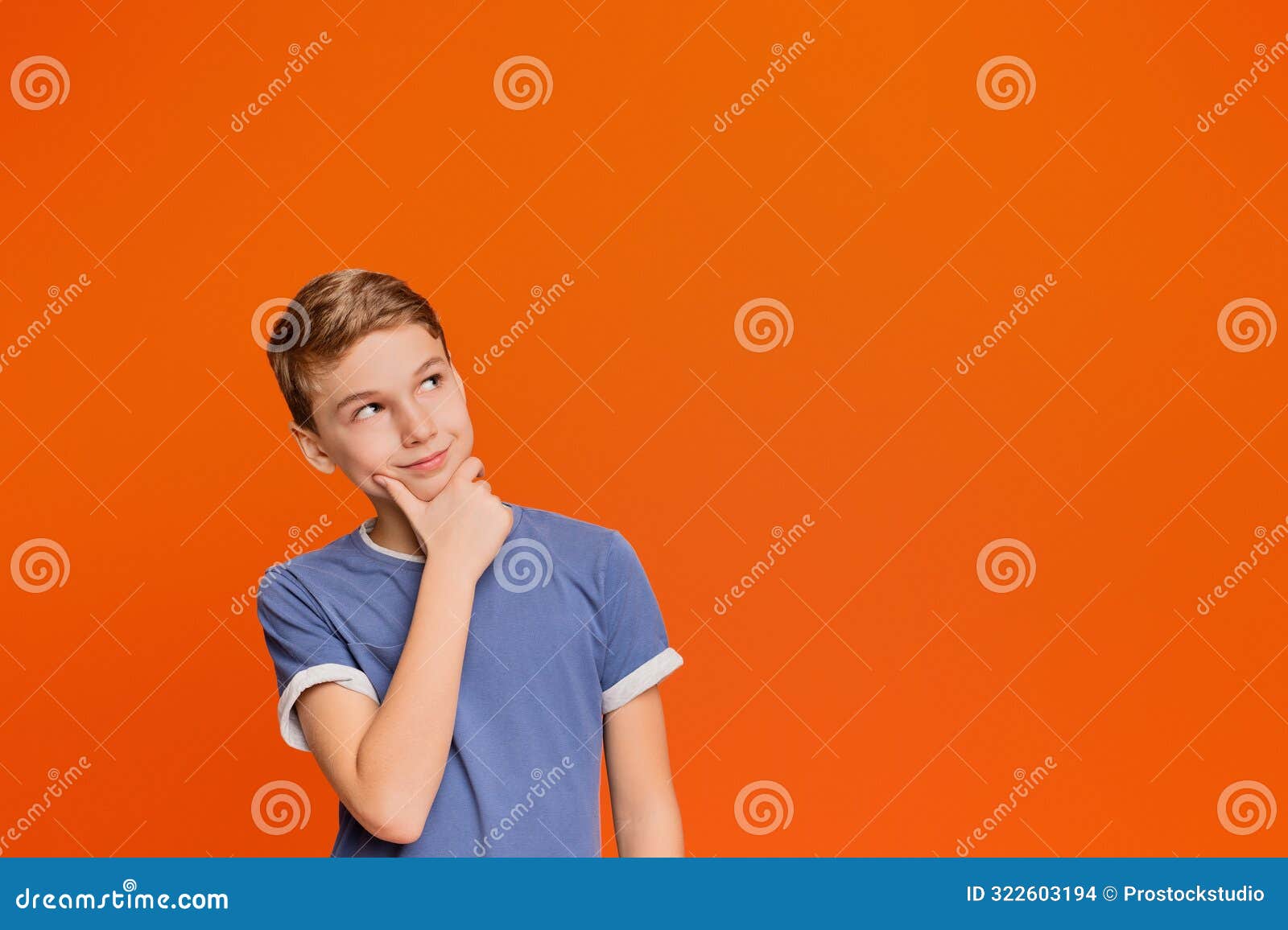 Pensive School Boy Thinking about Something on Orange Stock Photo ...