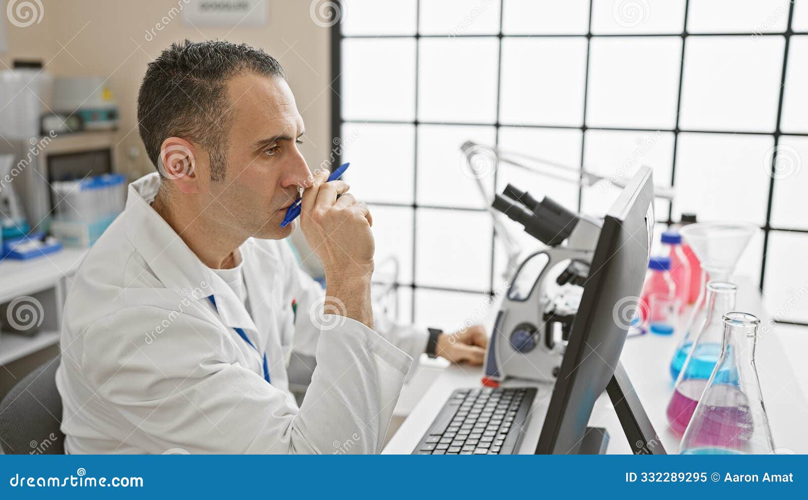Pensive Scientist Man in Lab Coat Analyzing Data on Computer in Modern ...