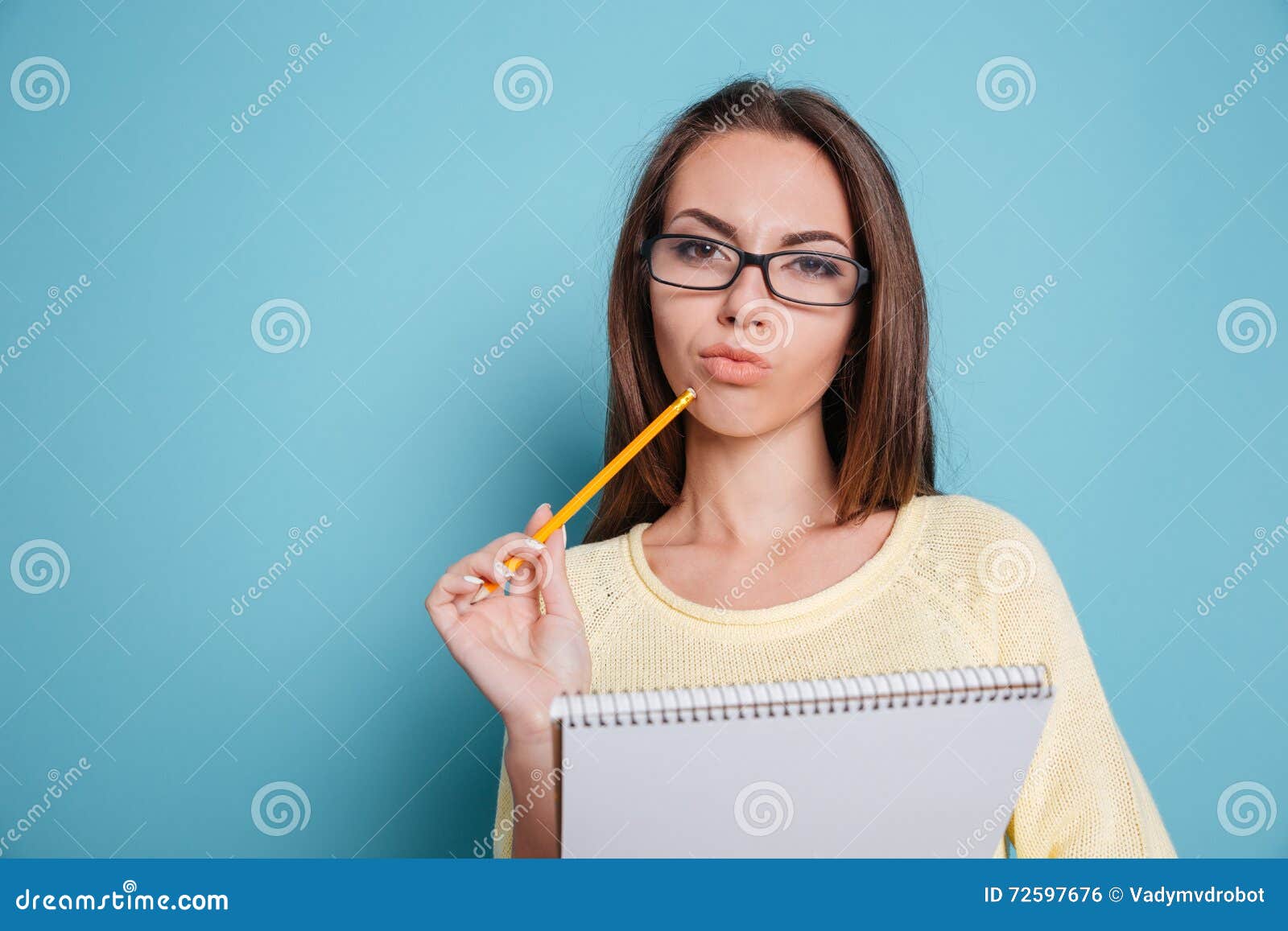 Pensive Smart Girl Thinking about Something and Holding Notebook Stock ...
