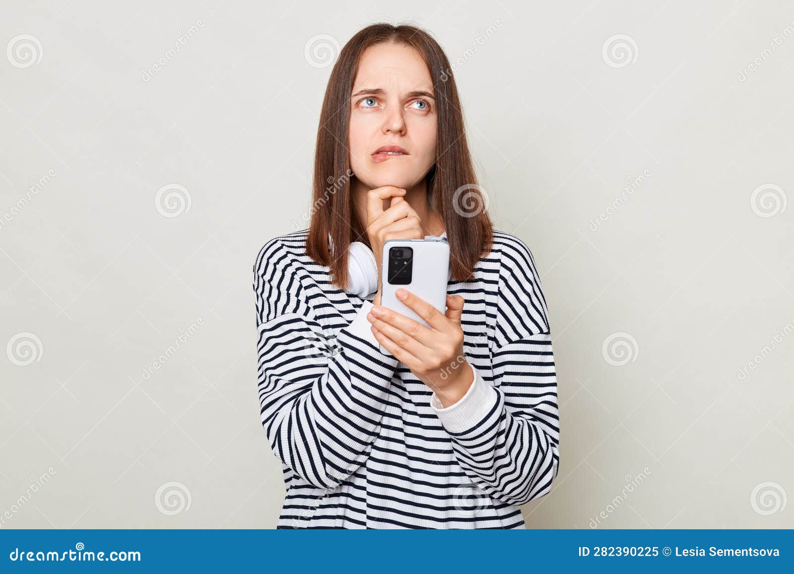 Pensive Thoughtful Brown Haired Adult Woman Wearing Striped Shirt