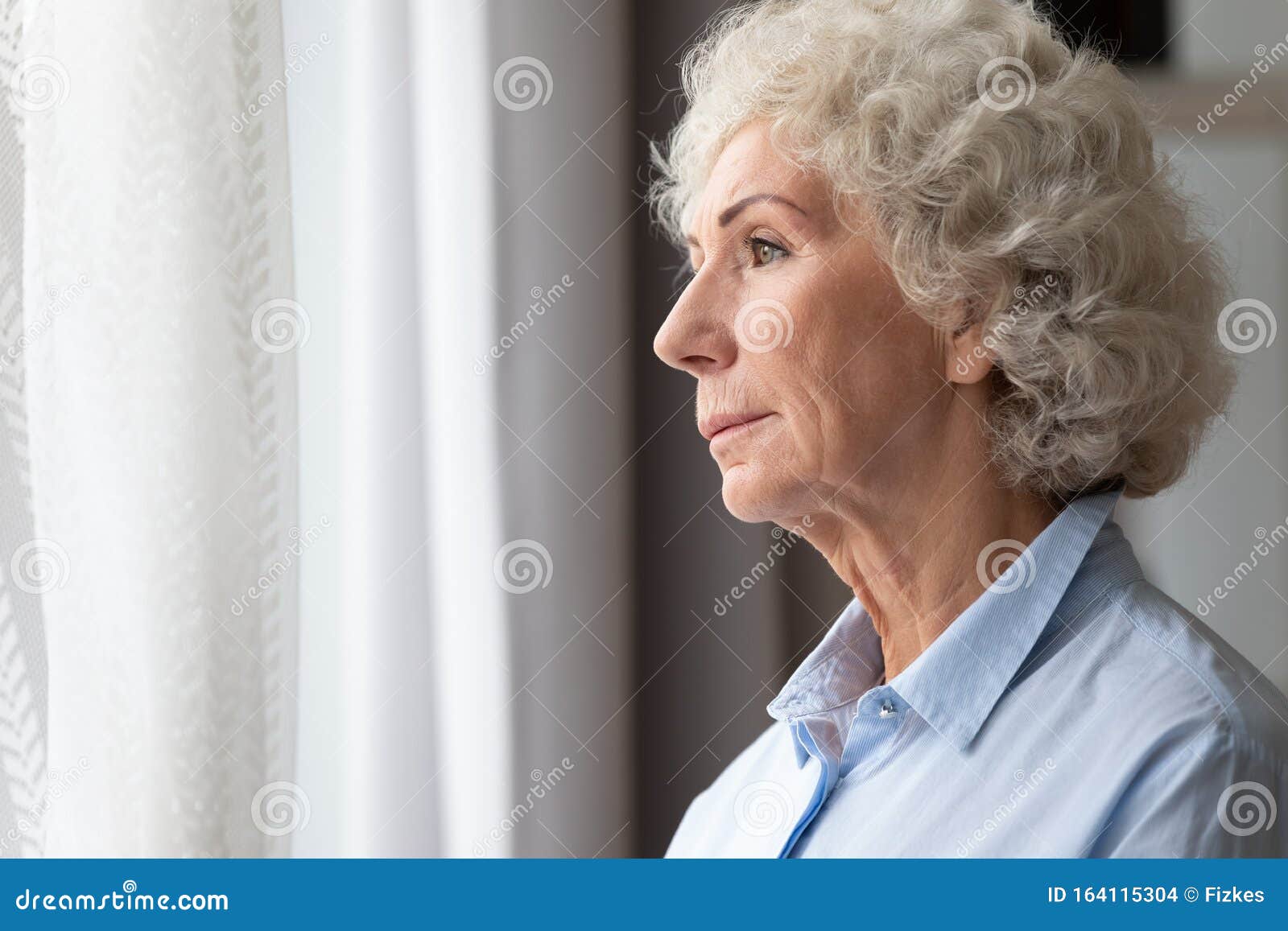 Pensive Thoughtful Lonely Senior Grandma Looking Through Window Stock