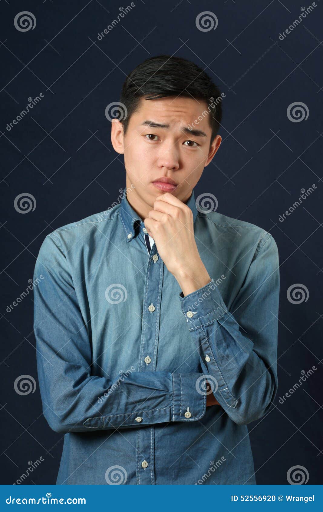 Pensive Young Asian Man Looking at Camera Stock Photo - Image of ...