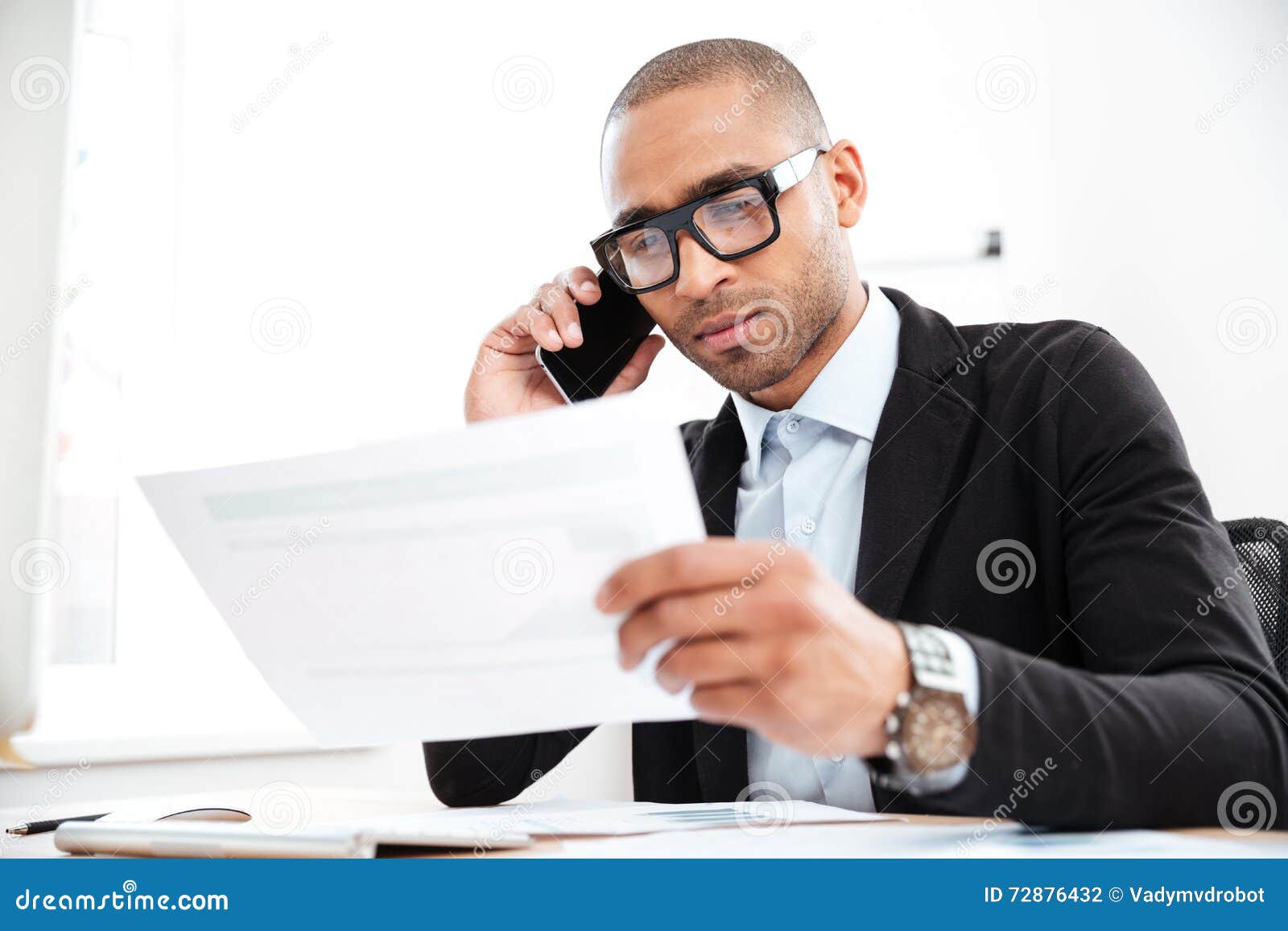 Pensive Young Businessman Looking at Documents in Office Stock Photo ...