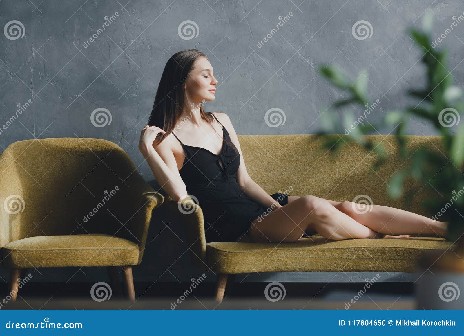 Pensive Young Girl in Black Lingerie Sitting on Sofa Stock Photo ... Pensive Young Girl in Black Lingerie Sitting on Sofa Stock Photo ...