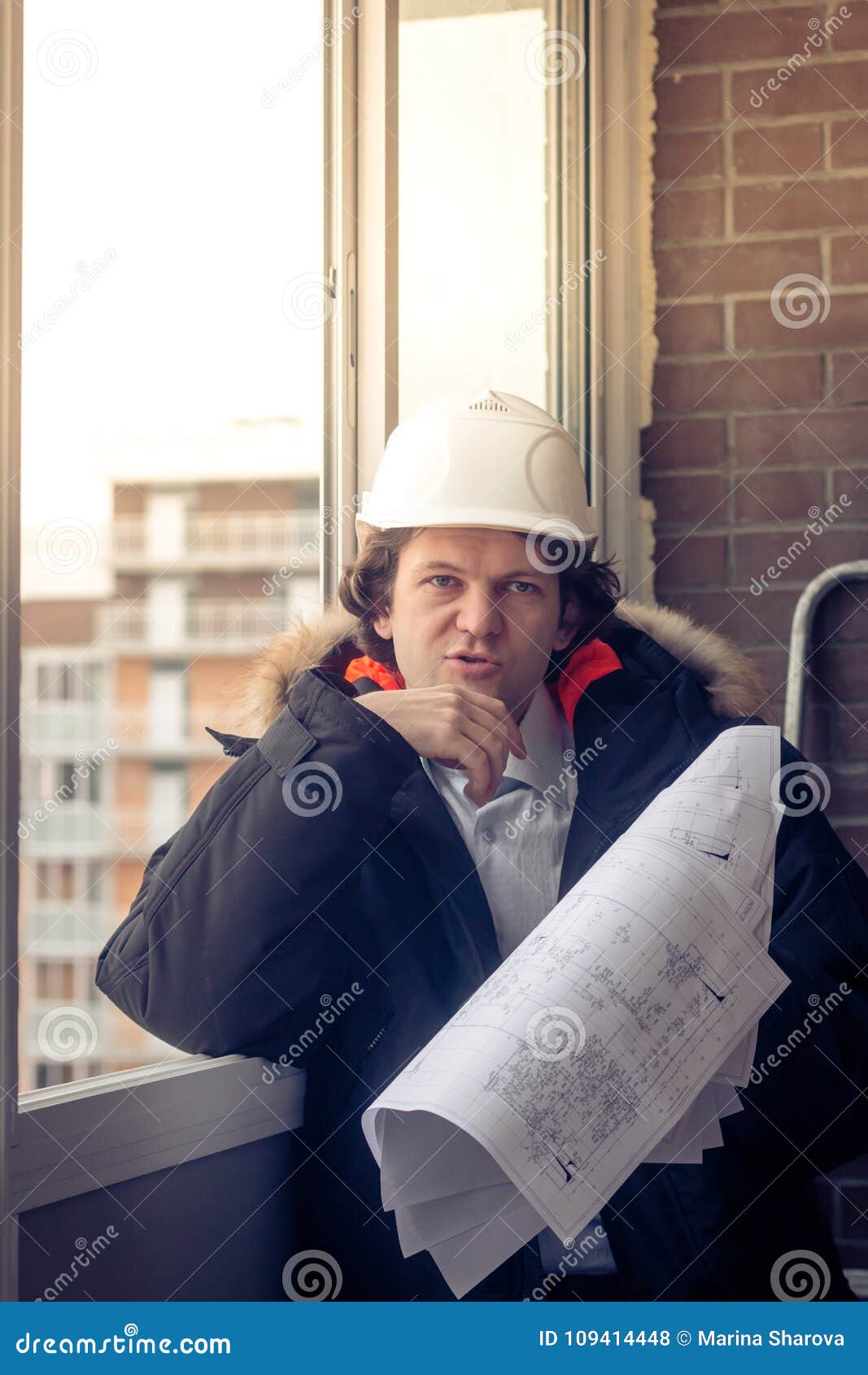 Pensive Young Man Builder in Hard Hat Standng and Thinking. Soft Focus ...