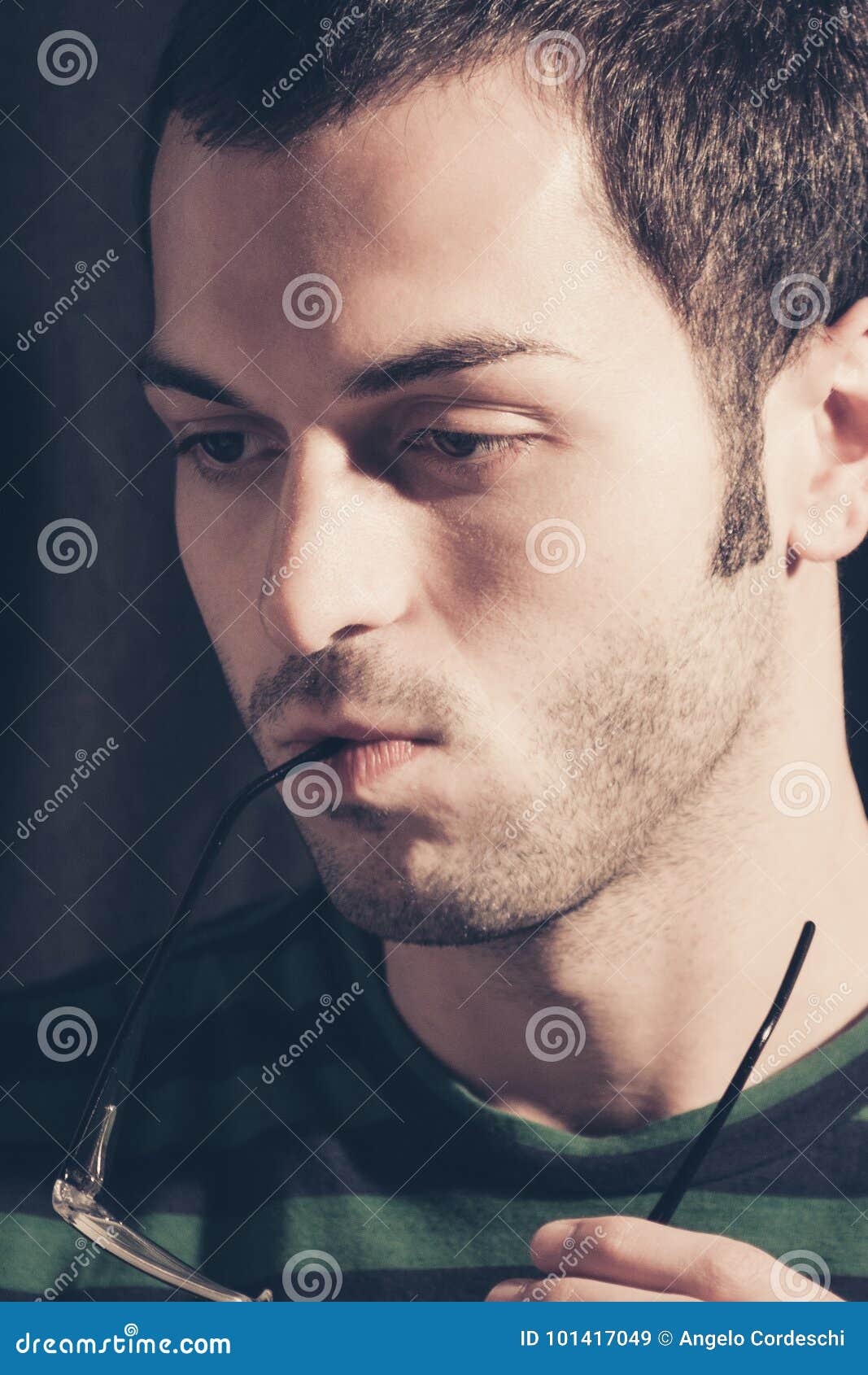 Pensive Young Man with Glasses in His Mouth Stock Image - Image of ...