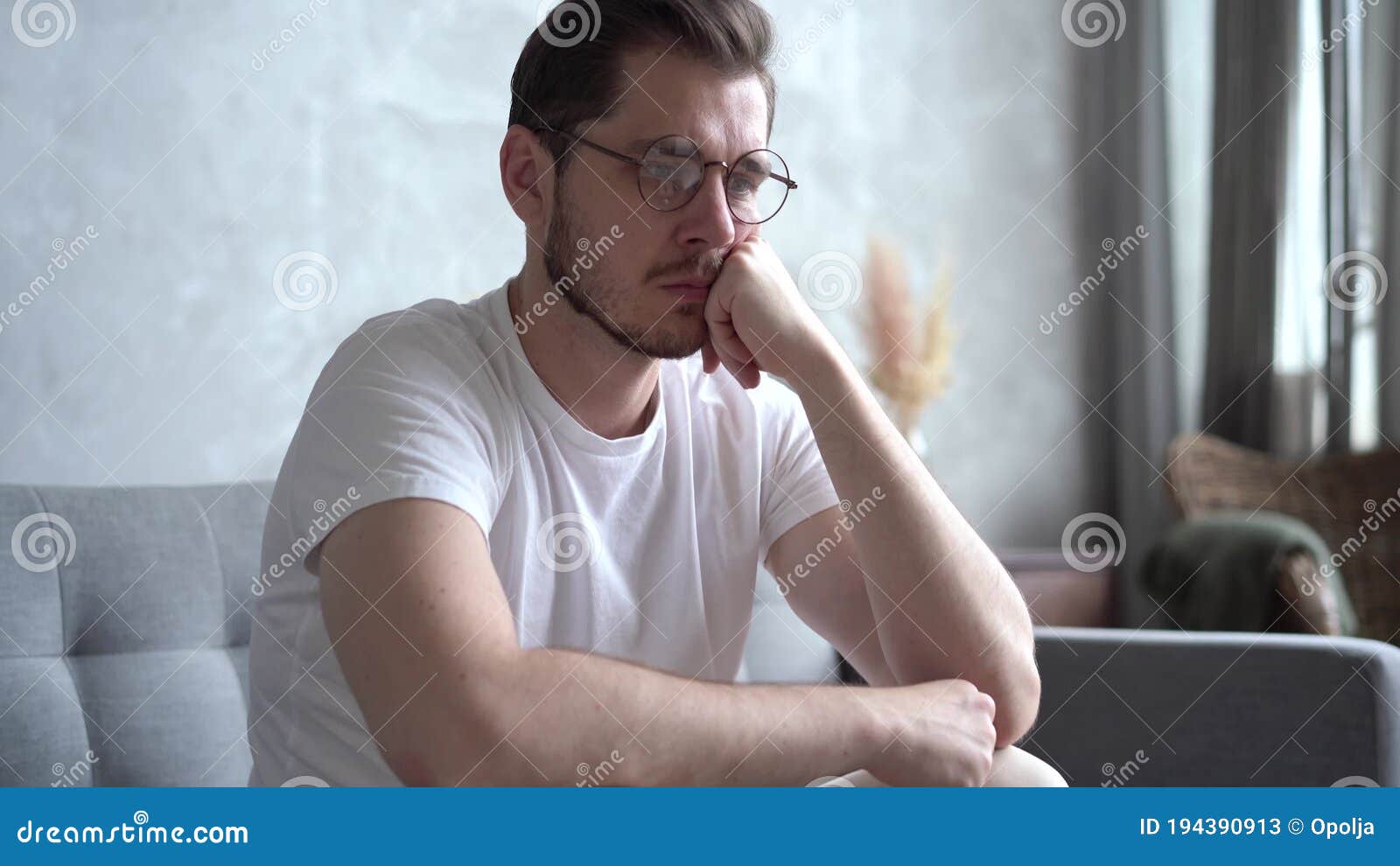 Pensive Young Man Sitting on Sofa and Thinking at Home. Stock Video ...