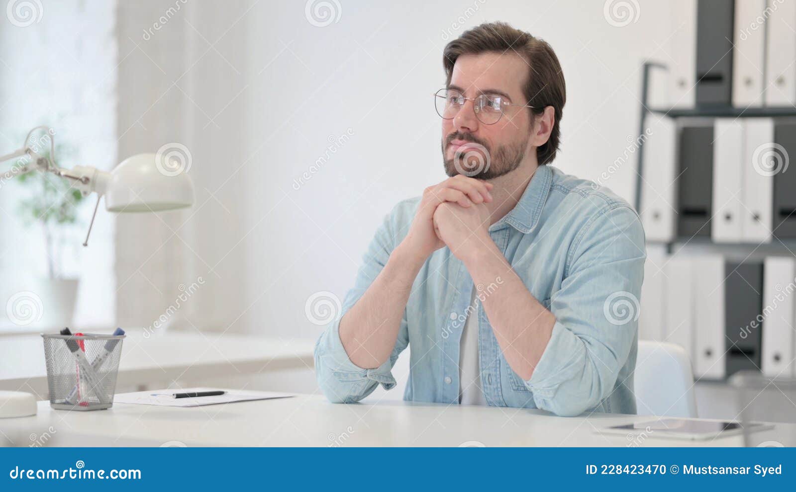 Pensive Young Man Thinking at Work Stock Photo - Image of working ...