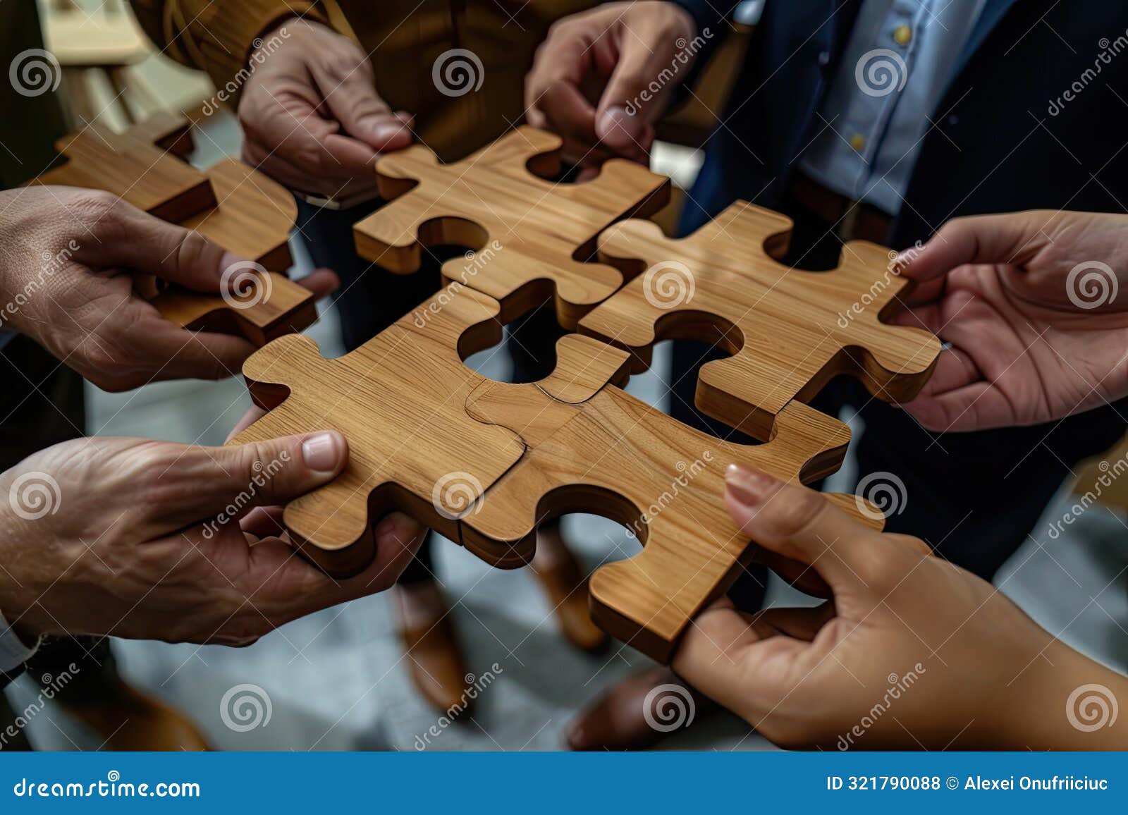 People Assembling Wooden Puzzle Pieces on a Table Stock Photo - Image ...