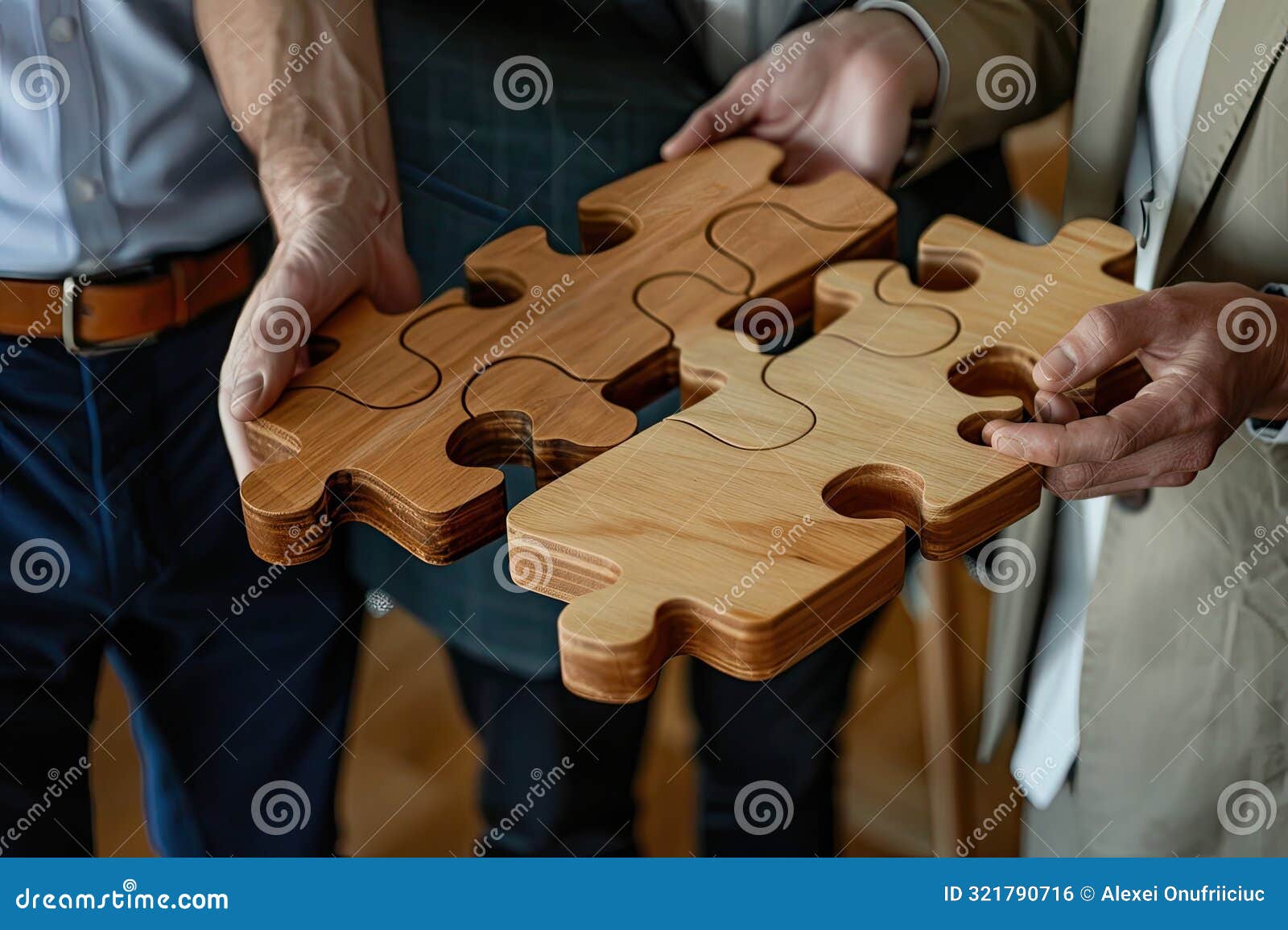 People Assembling Wooden Puzzle Pieces on a Table Stock Photo - Image ...