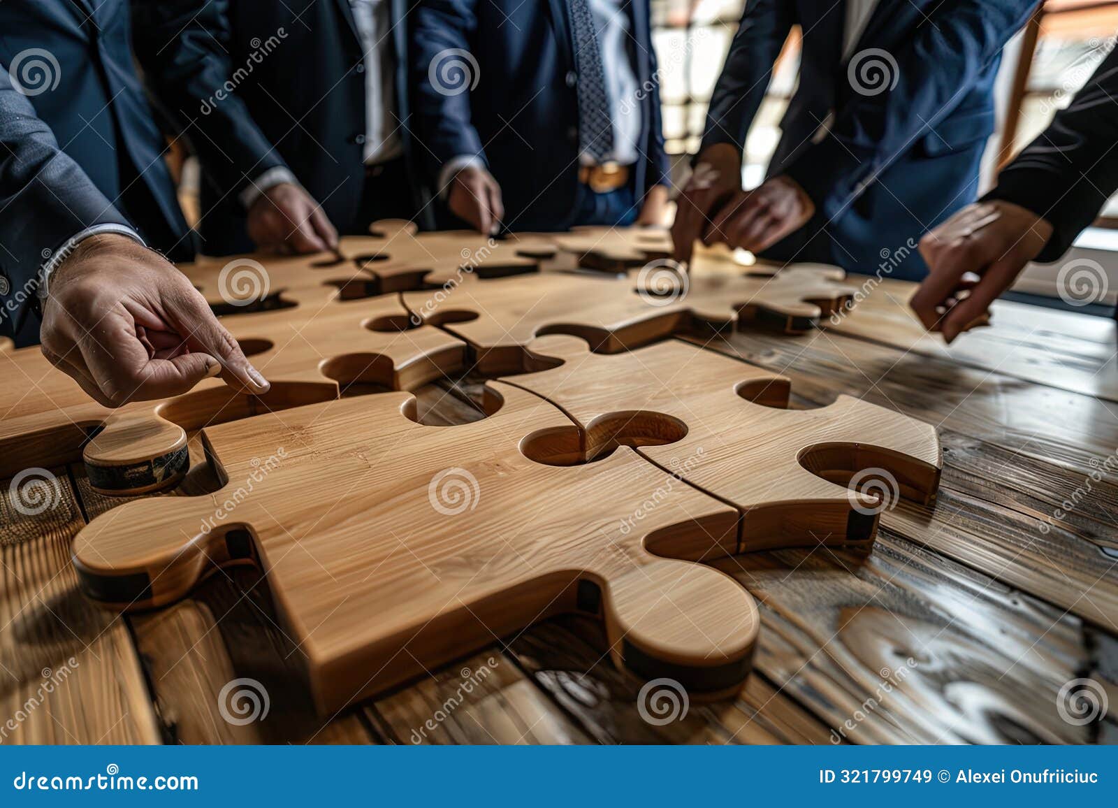 People Assembling Wooden Puzzle Pieces on a Table Stock Image - Image ...