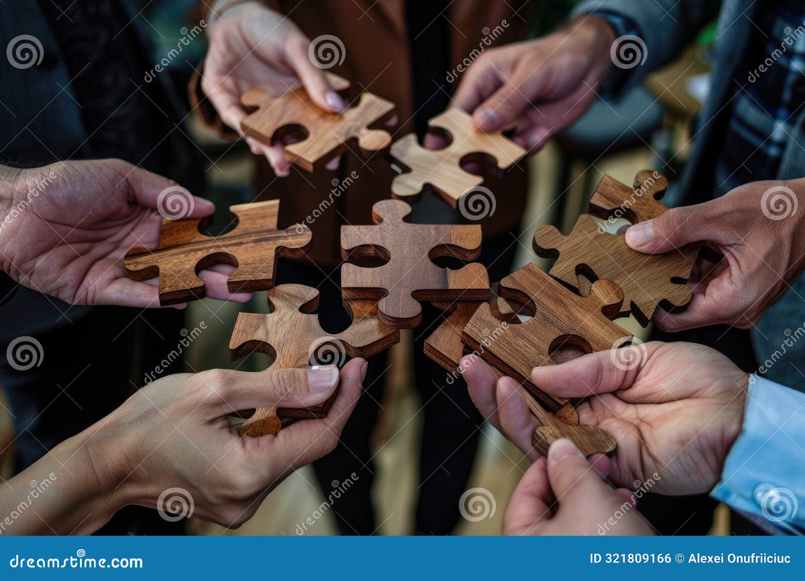 People Assembling Wooden Puzzle Pieces on a Table Stock Photo - Image ...