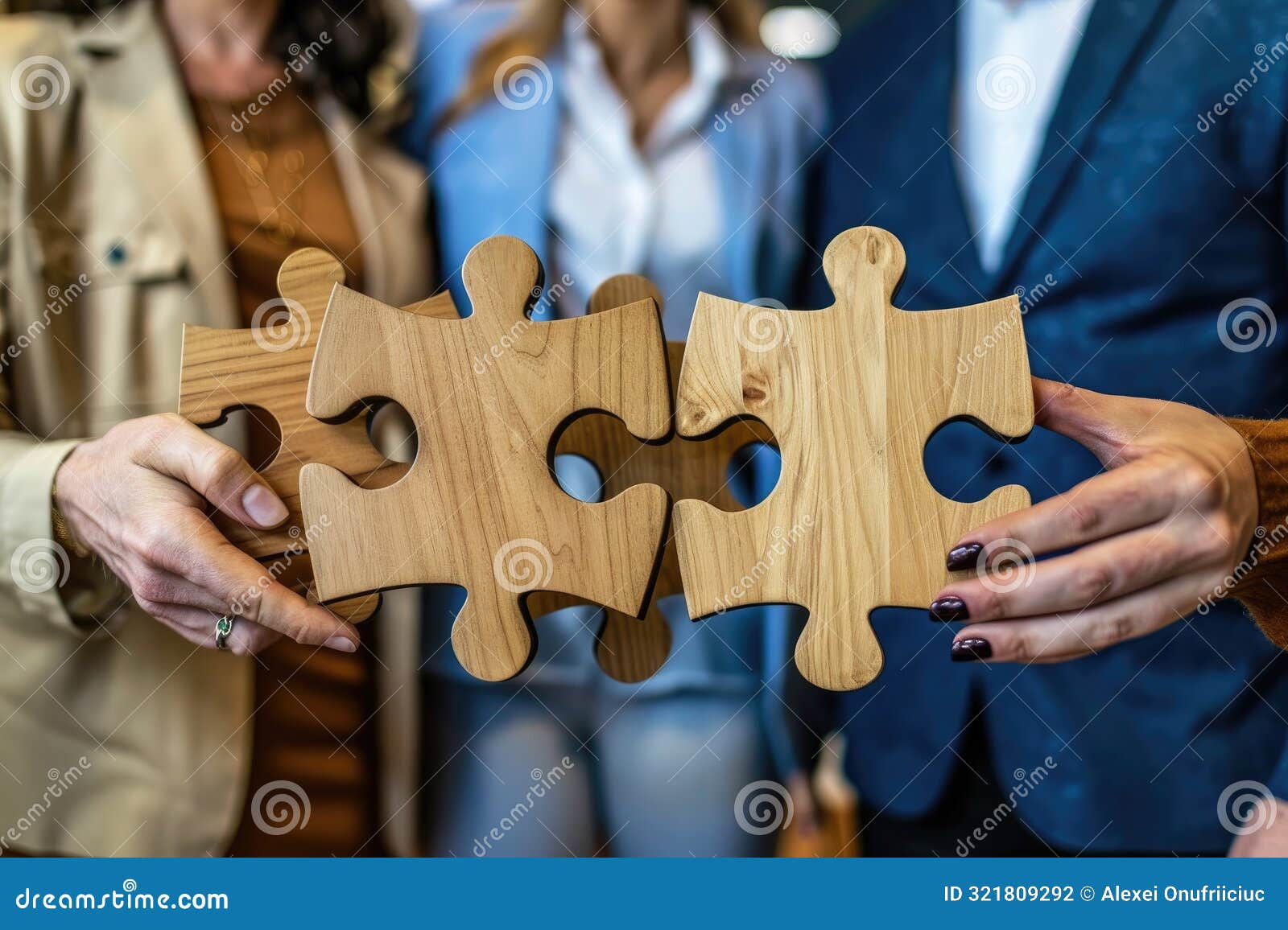 People Assembling Wooden Puzzle Pieces on a Table Stock Photo - Image ...