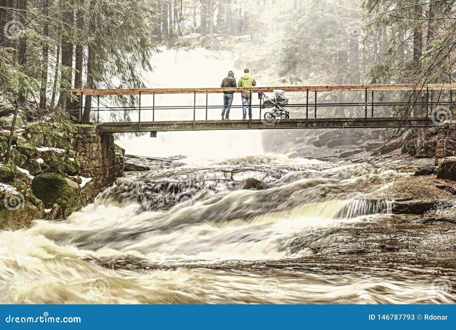 People with Baby on Bridge Stretched Over Flood Mountain River Stock ...