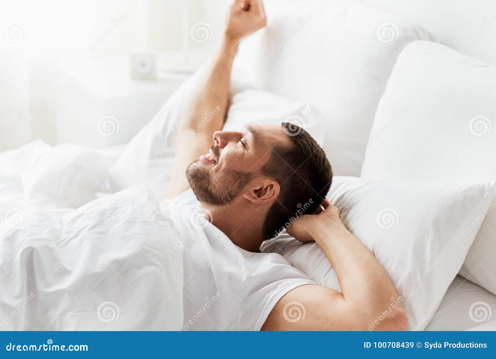 Man lying in bed at home stock image. Image of people - 100708439