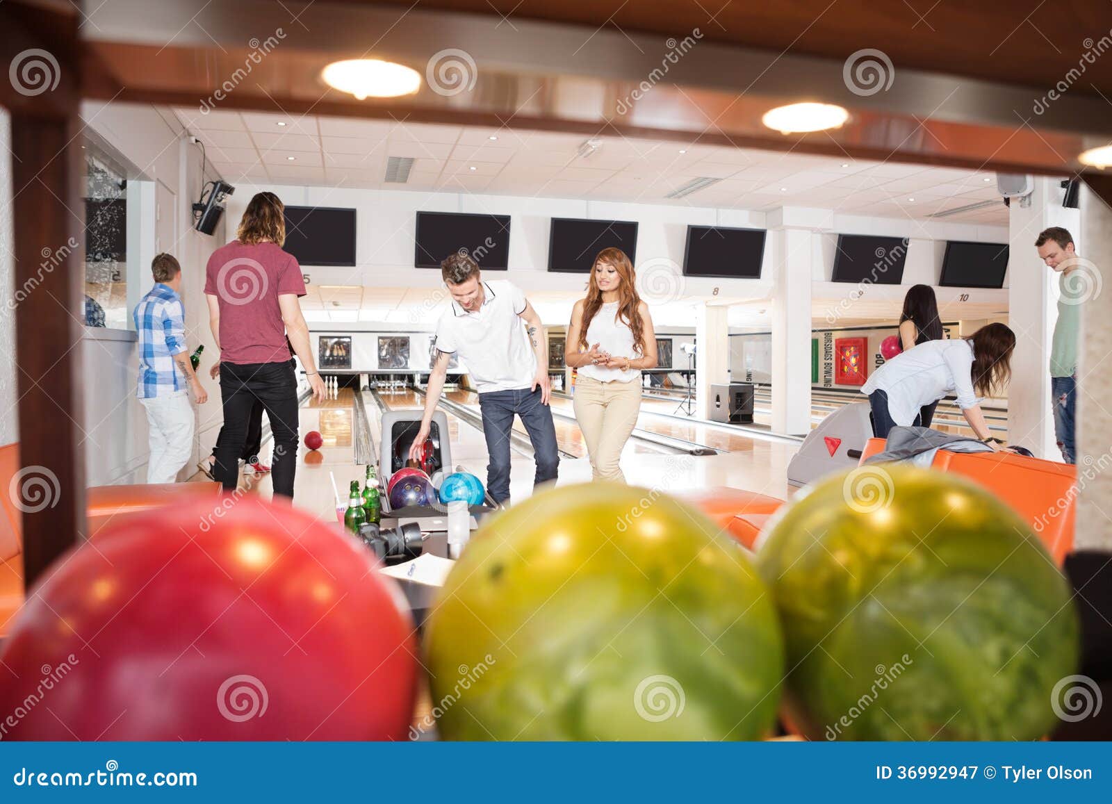 People Bowling with Balls in Foreground Stock Image - Image of friend ...