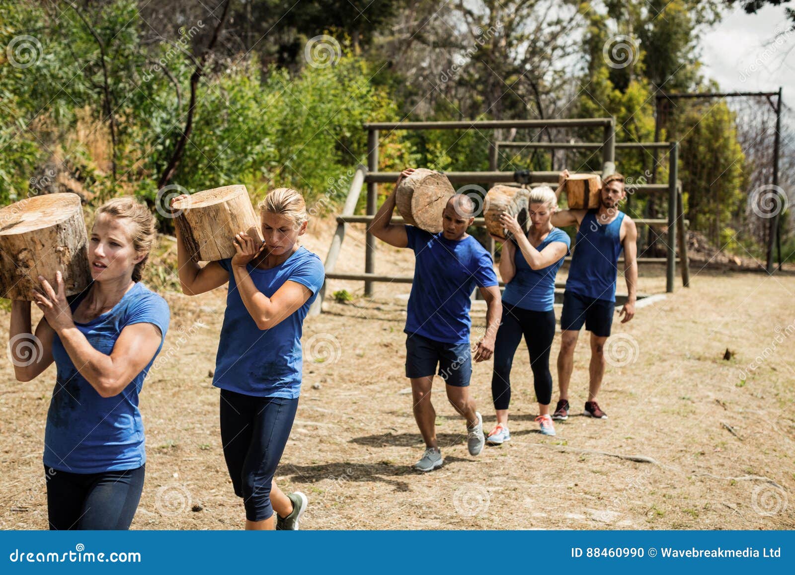 People Carrying Heavy Wooden Logs during Obstacle Course Stock Photo ...