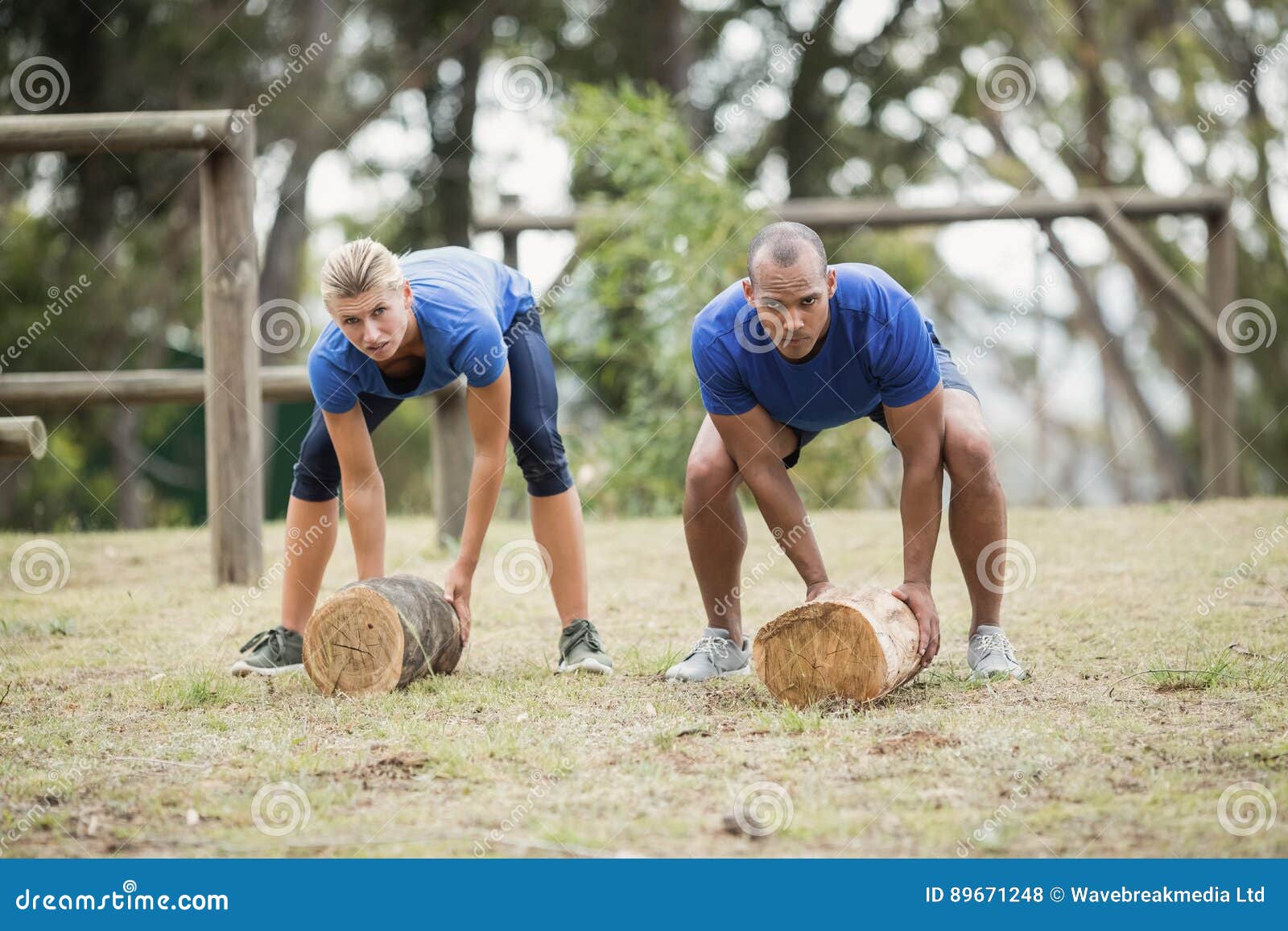 People Carrying Heavy Wooden Logs during Obstacle Course Stock Photo ...