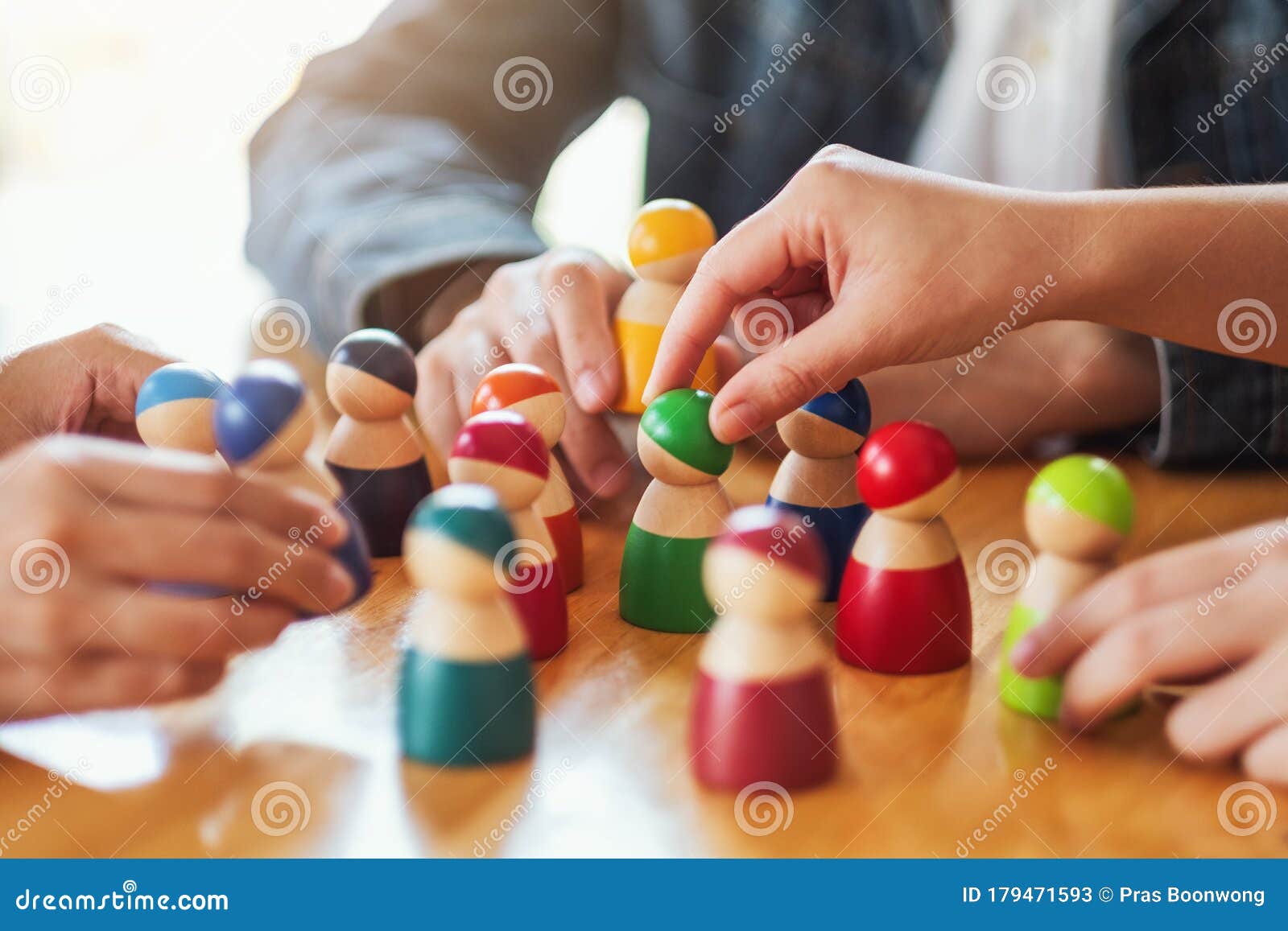 People Choosing and Picking Up Wooden Figure from a Group Stock Image ...