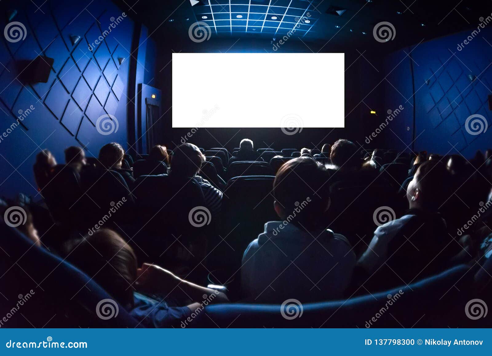 People In The Cinema Watching A Movie. Blank Empty White Screen ...