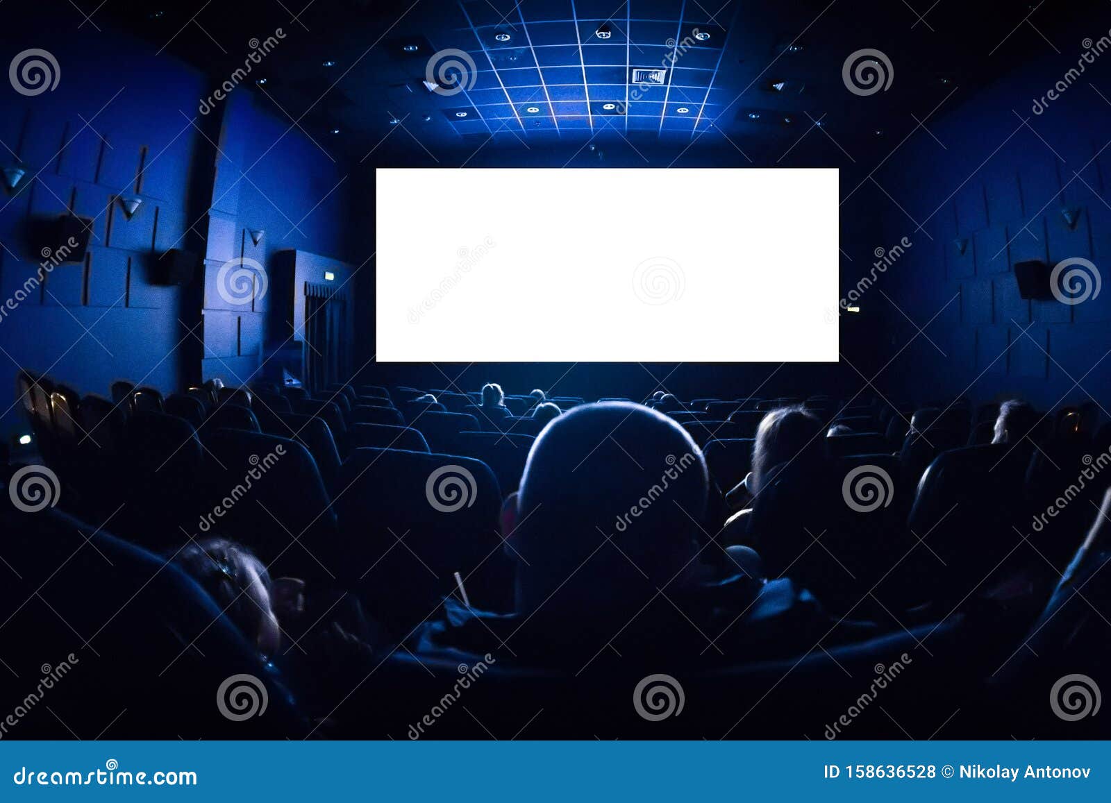 People in the Cinema Watching a Movie. Blank Empty White Screen Stock ...