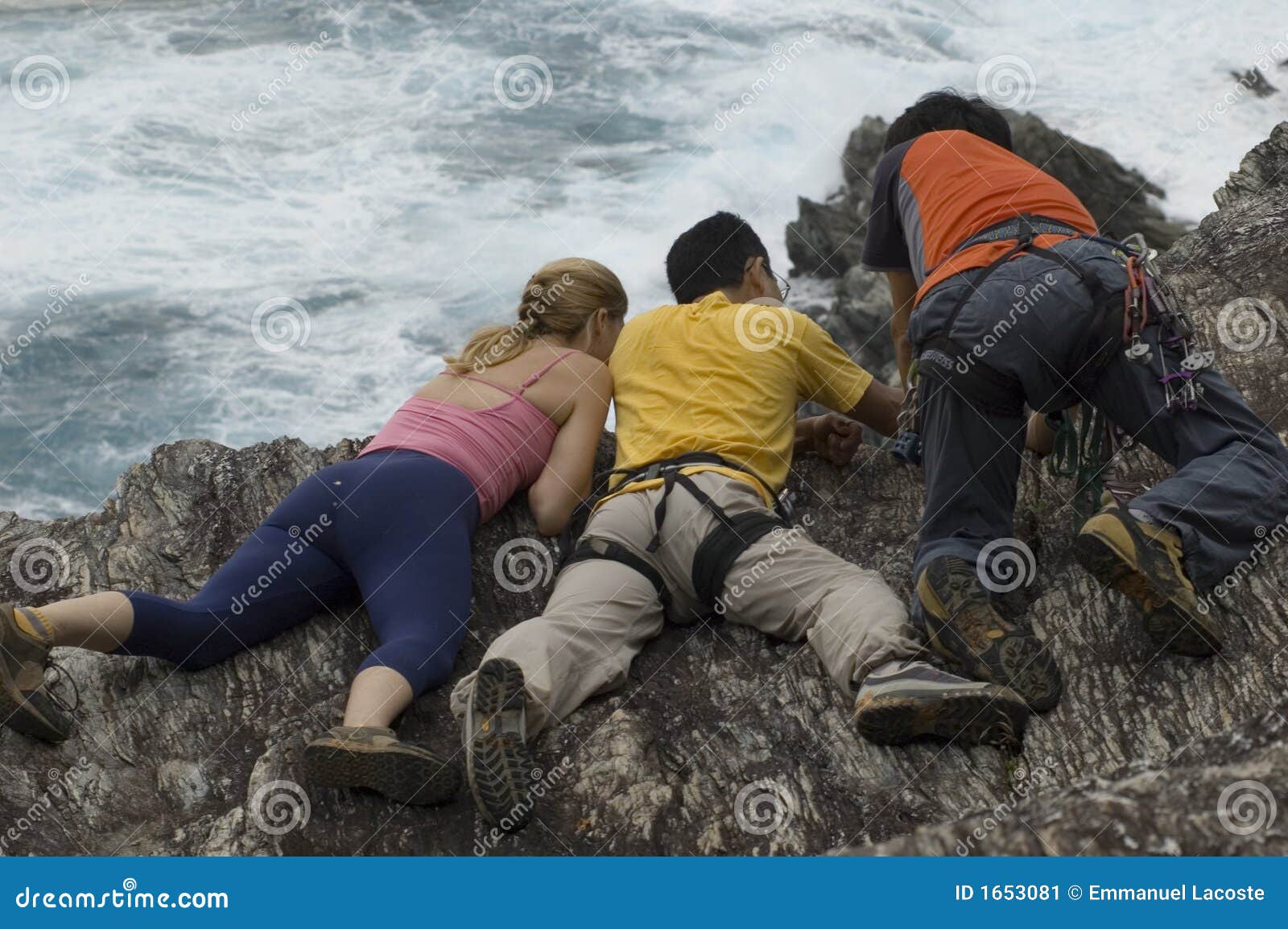 People on Cliff Above Ocean Stock Image - Image of belts, danger: 1653081