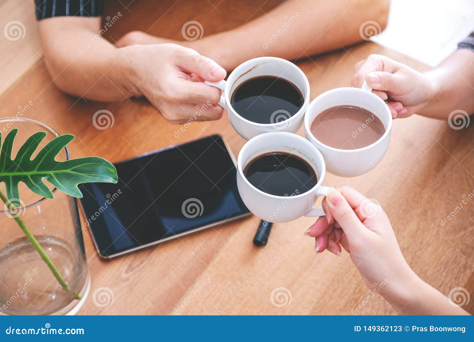People Clinking Coffee Cups on Wooden Table in Cafe Stock Image - Image ...