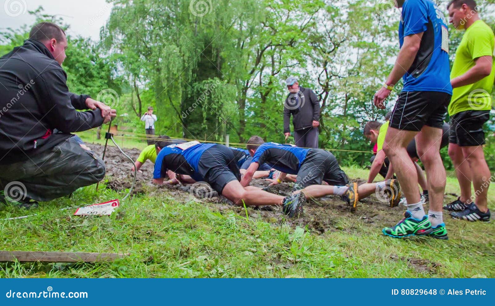 People Crawling through Mud As Part of Obstacle Course Stock Footage ...